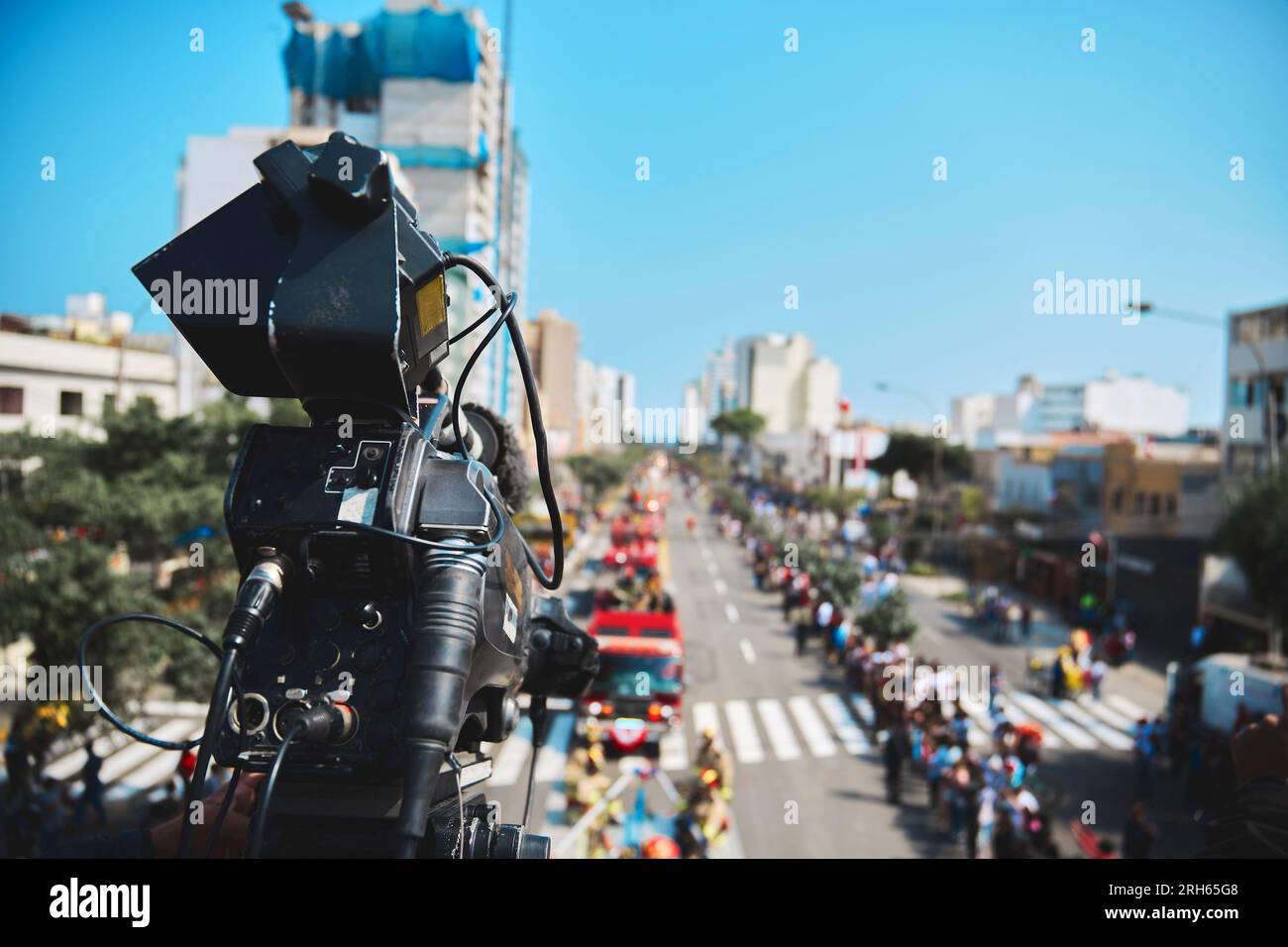 Making news, media cameraman at a public protest, blurred crowd in the ...