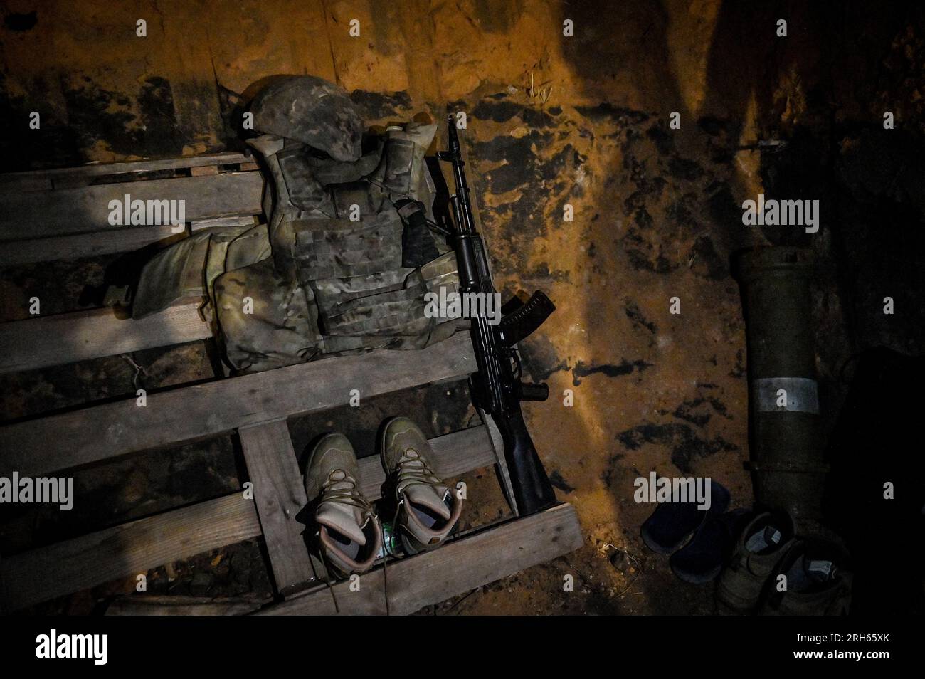 UKRAINE - AUGUST 11, 2023 - A helmet, bulletproof vest, rifle and shoes ...