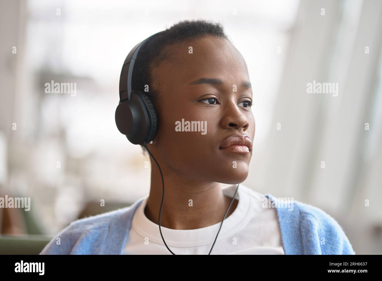 African Black generation z girl with short hair sitting wearing ...