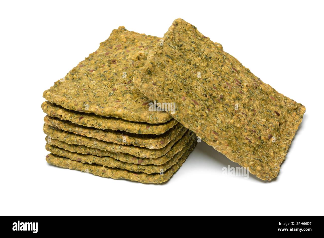 Heap of vegetable crackers seasoned with spinach isolated on white ...