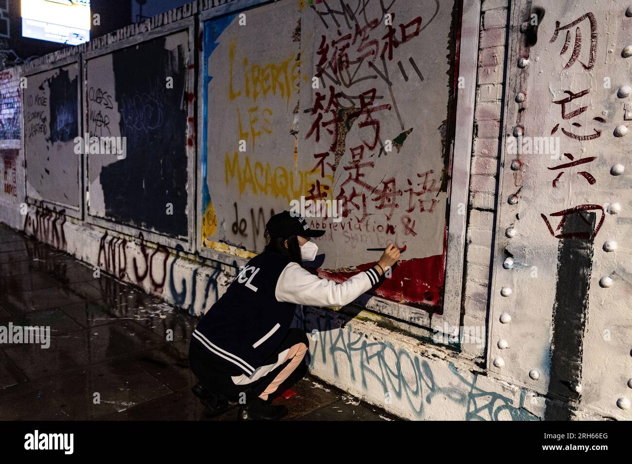 An activist from wearechainwoman paints Anti-Beijing counter-message in ...
