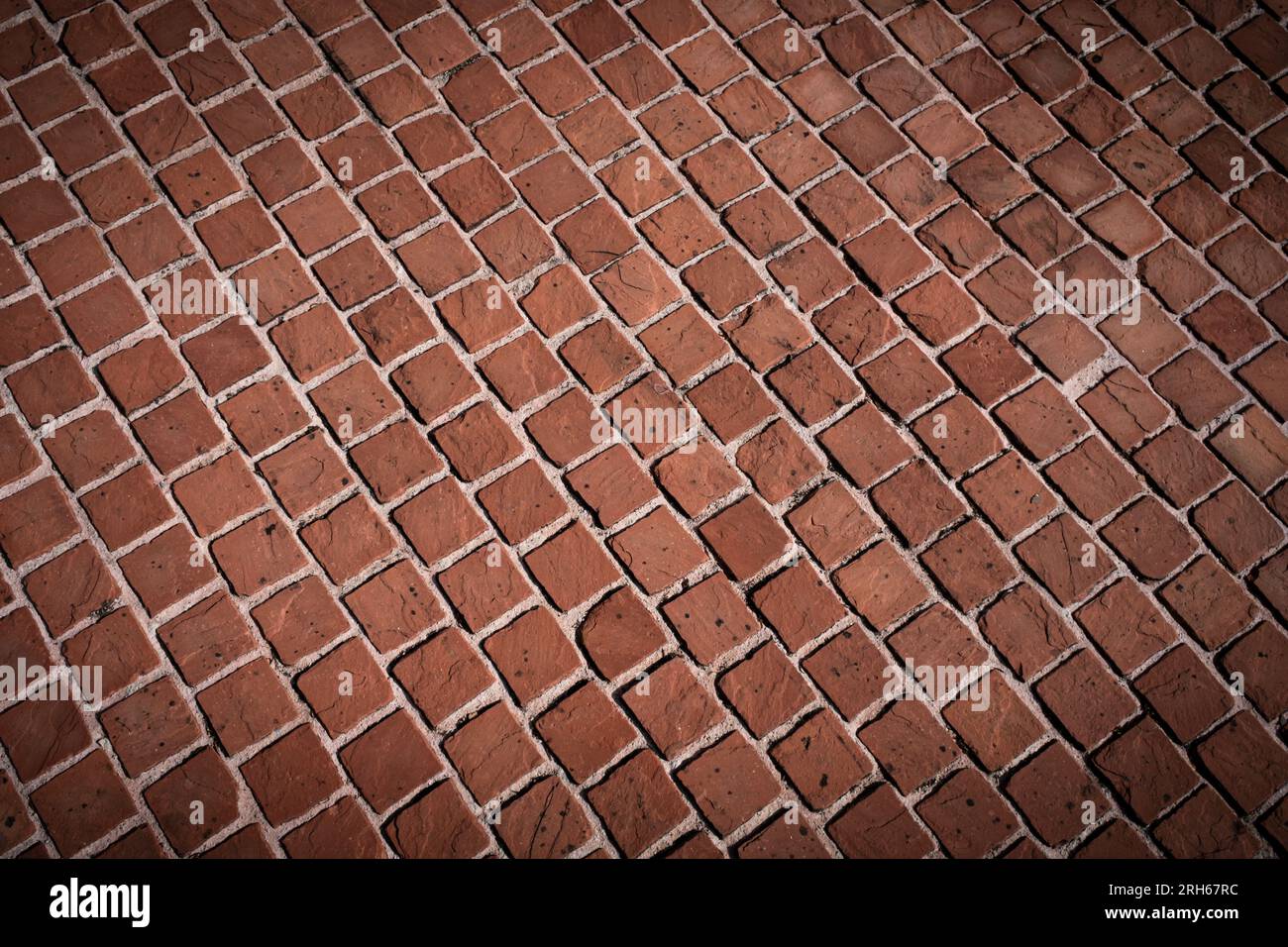 Antique floor texture made of reddish-coloured cobblestones with ...
