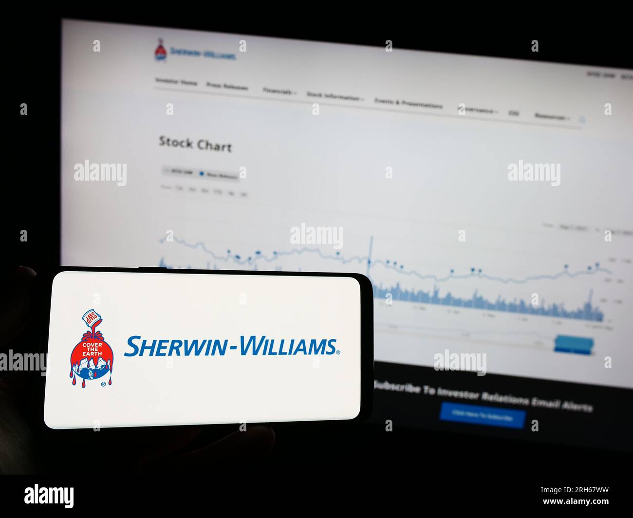 Person holding mobile phone with logo of US paints business The Sherwin ...