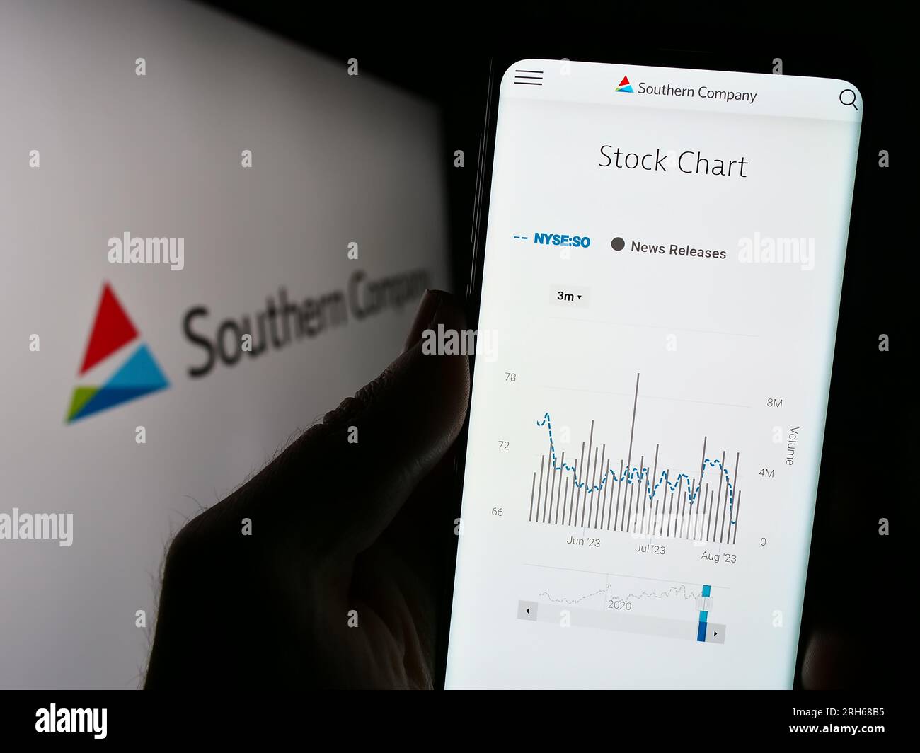 Person holding cellphone with website of US utility business Southern ...