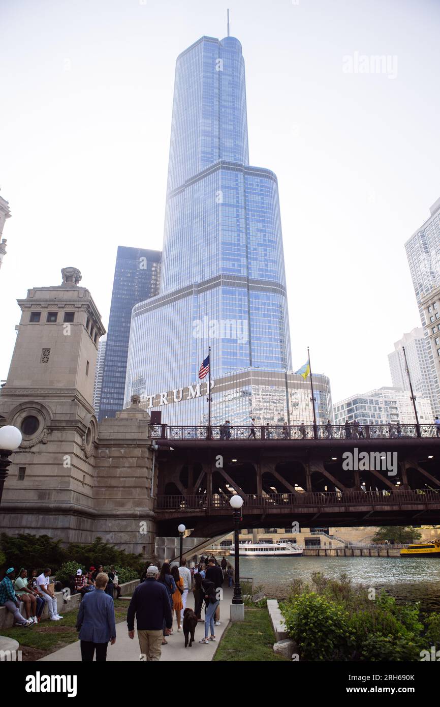 People by the Chicago Riverwalk near DuSable Bridge with Trump Tower in ...