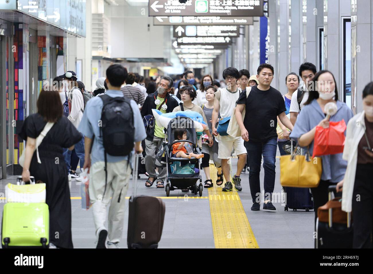 Passengers are pictured while Typhoon No.7 (Lan) approaching the main ...