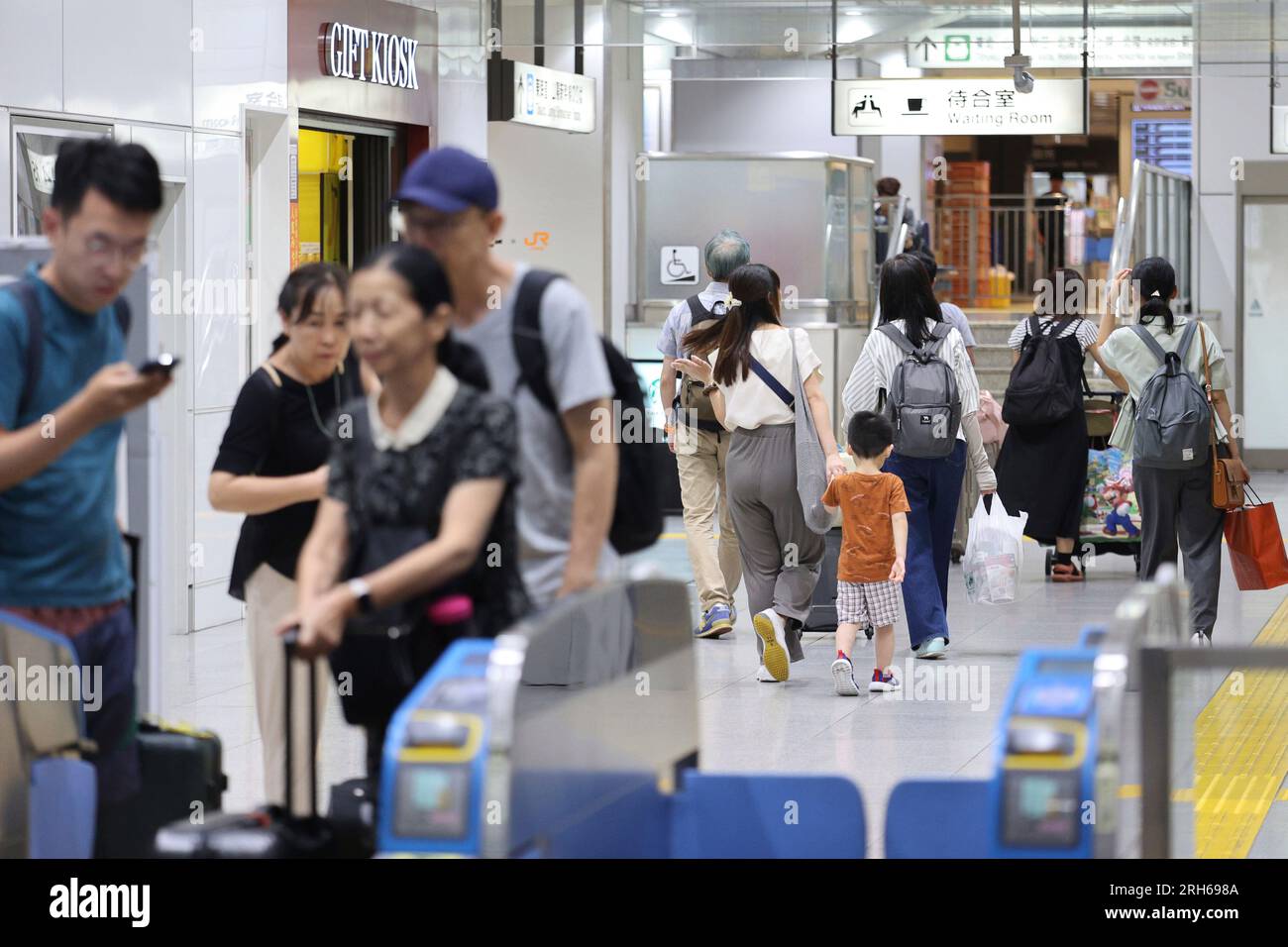 Passengers are pictured while Typhoon No.7 (Lan) approaching the main ...