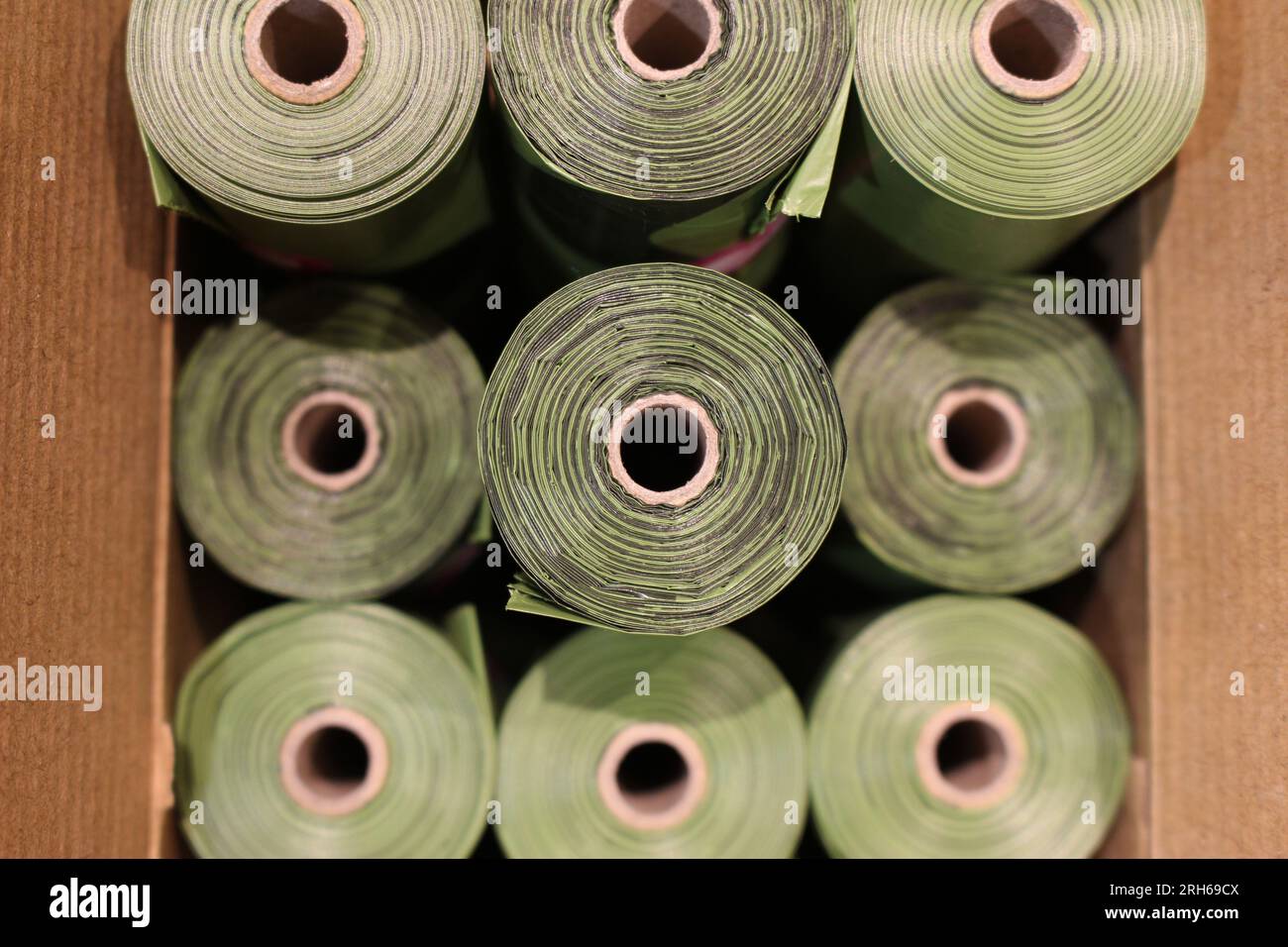 Top down view of industrial green plastic bags rolled up over a ...