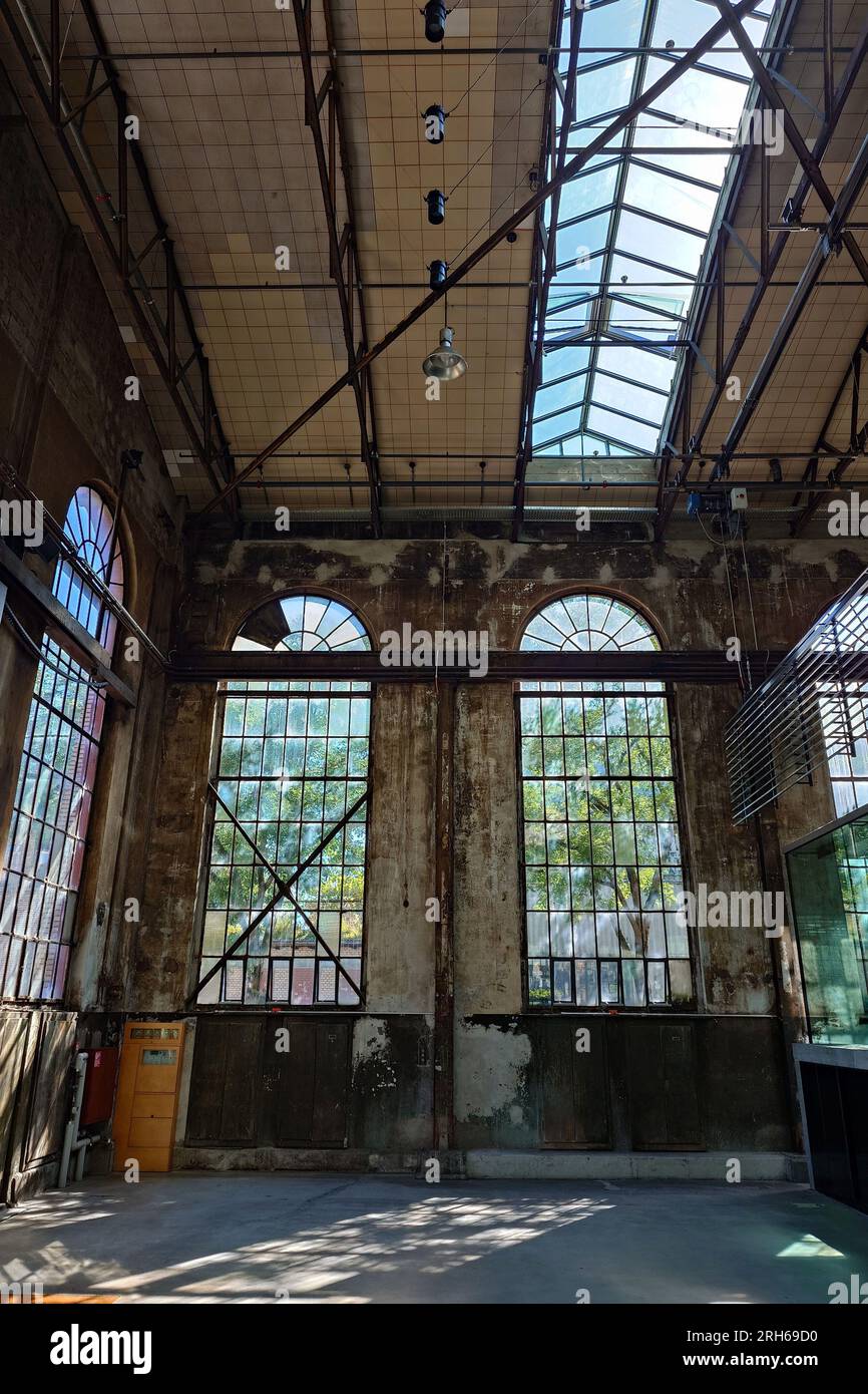 Very large windows inside an old industrial factory space. Natural ...