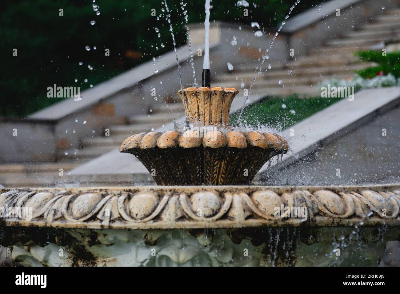 Fountain in the park with water splashes . Marble carved fountain Stock ...
