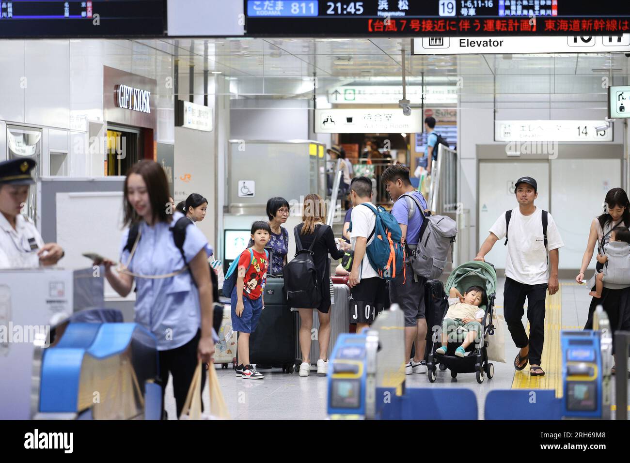 Passengers are pictured while Typhoon No.7 (Lan) approaching the main ...