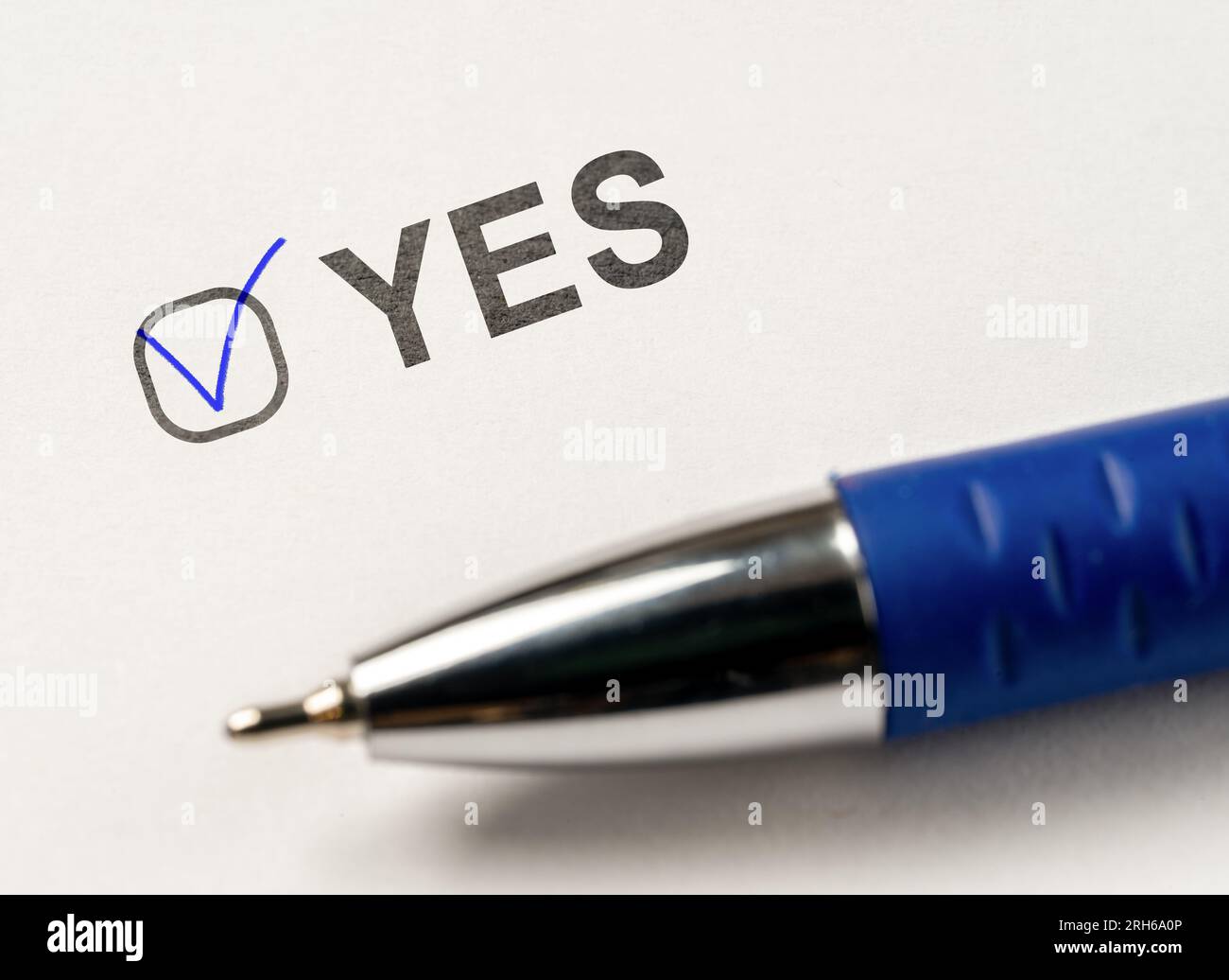 checkbox YES. marked with tick mark and blue pen on white paper ...