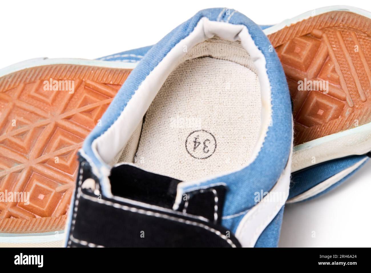 Used blue pair of baby sneakers isolated on white background one over ...