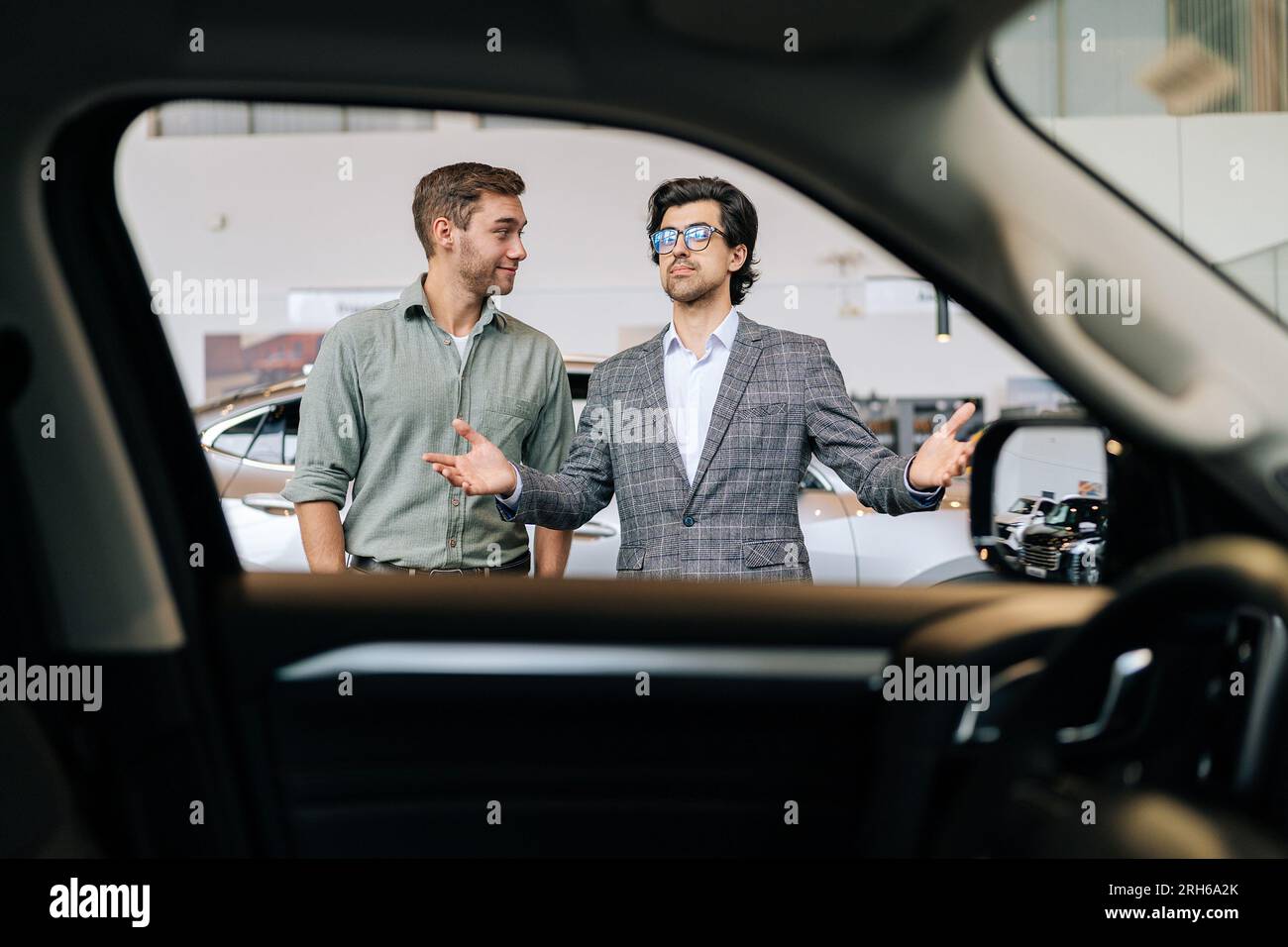 View from interior of car to professional car dealer selling new ...