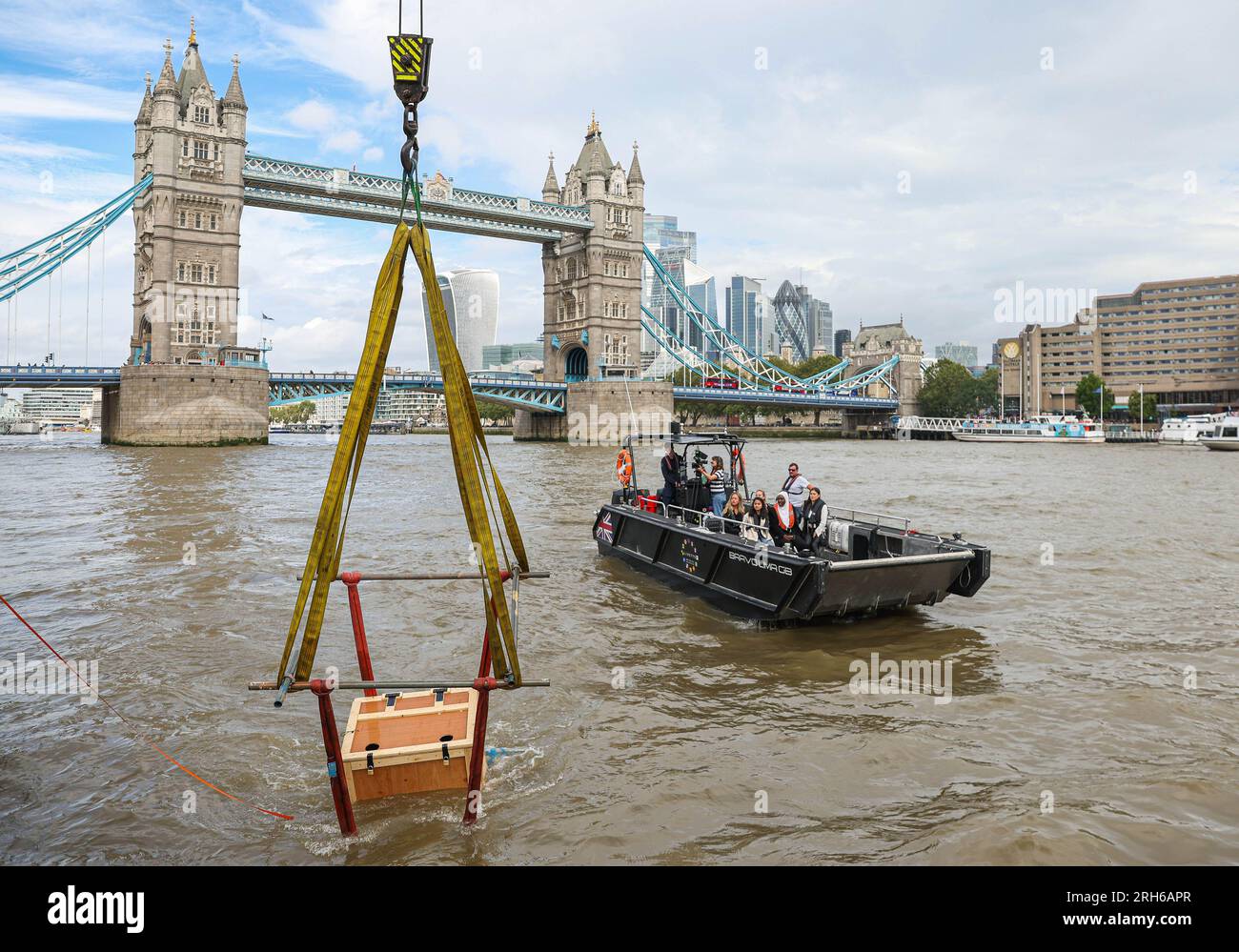EDITORIAL USE ONLY A locked crate is lowered into the River Thames as ...
