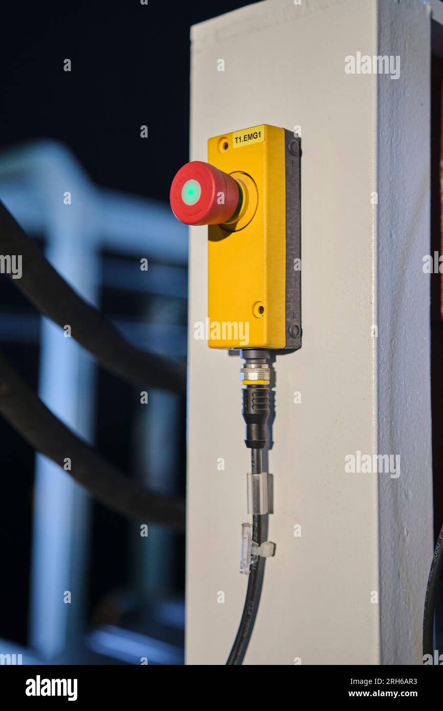 big red button in a factory. yellow base, red button and green light on ...