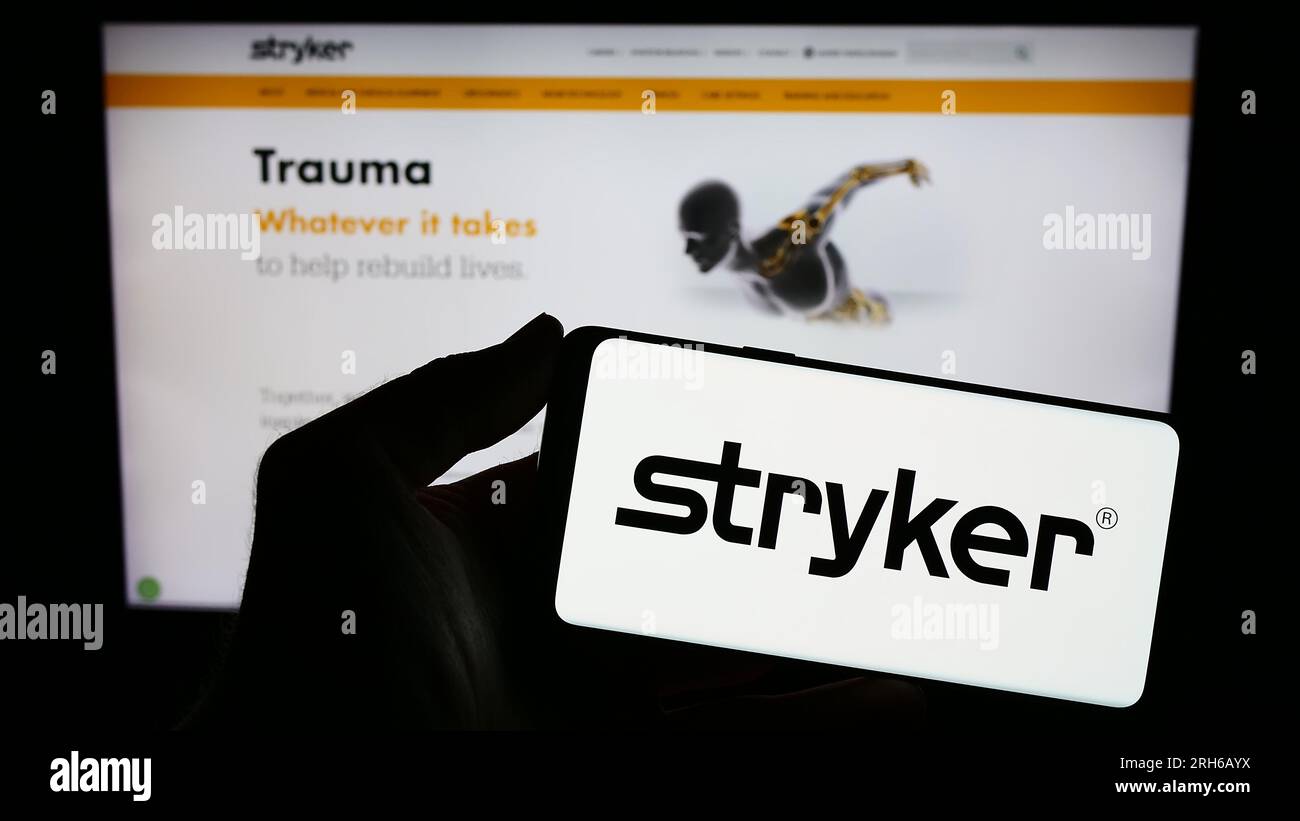 Person holding smartphone with logo of US medical technology company ...