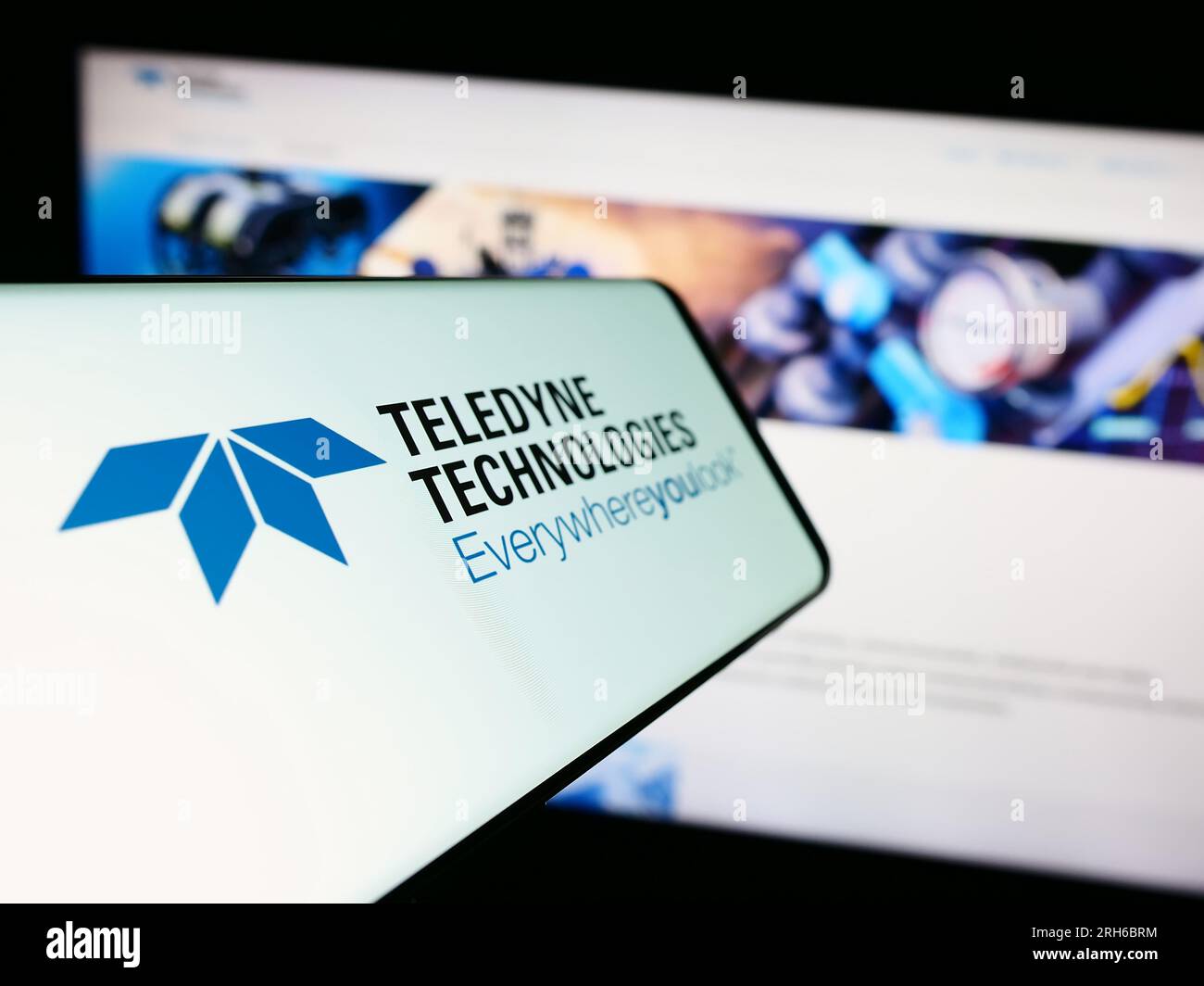 Mobile phone with logo of US company Teledyne Technologies Incorporated on screen in front of ...