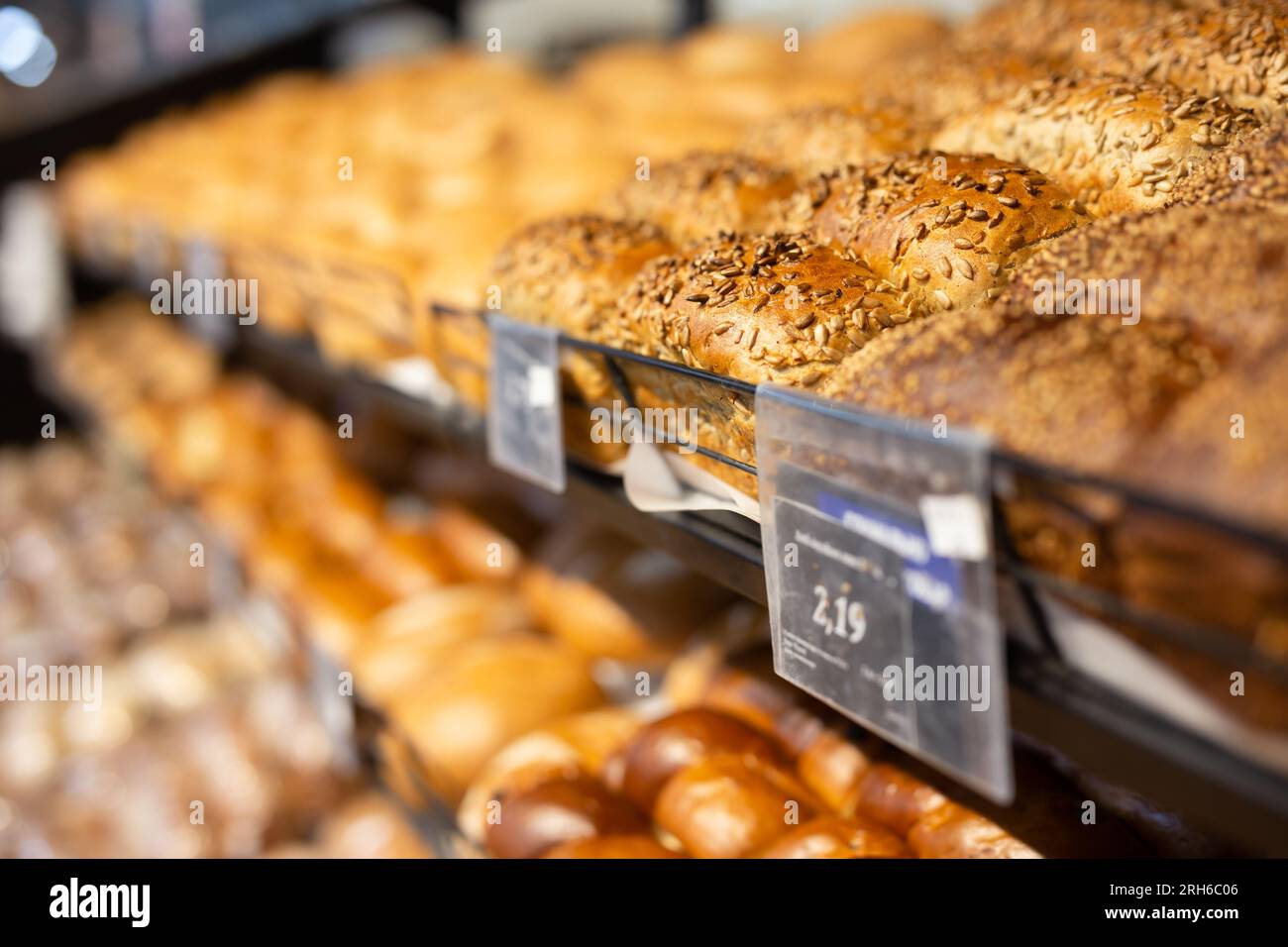 Fresh golden breads on the shelf of the bread section of the ...