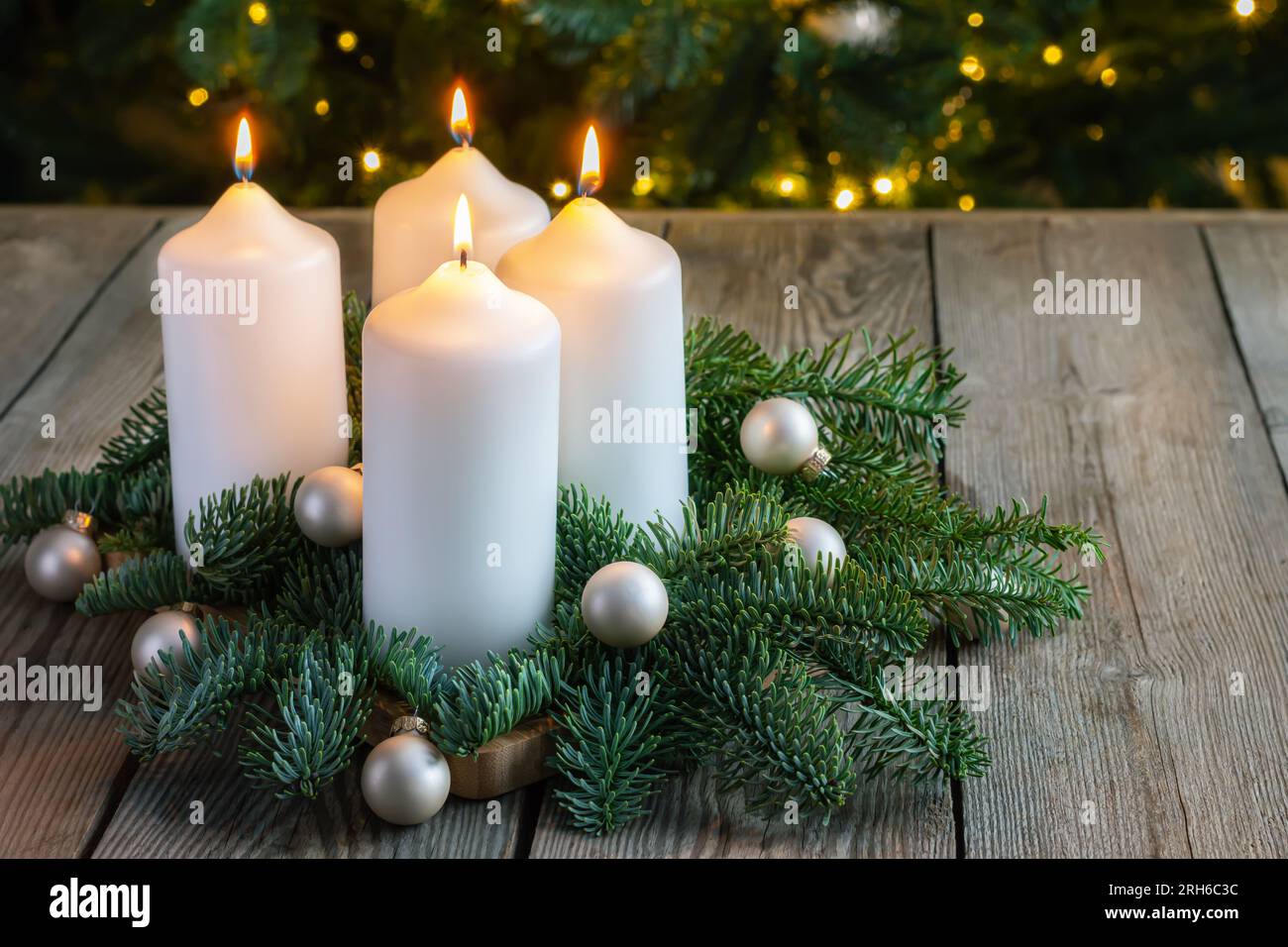 Advent wreath with four white candles, fir branches on wooden ...