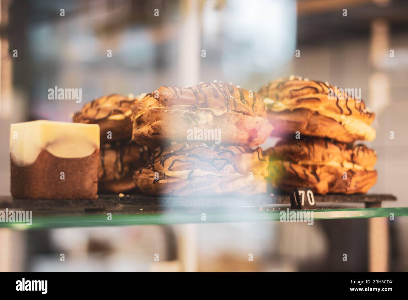 Creamy cakes in cafe showcase with price tag. Fresh pastry in cake ...