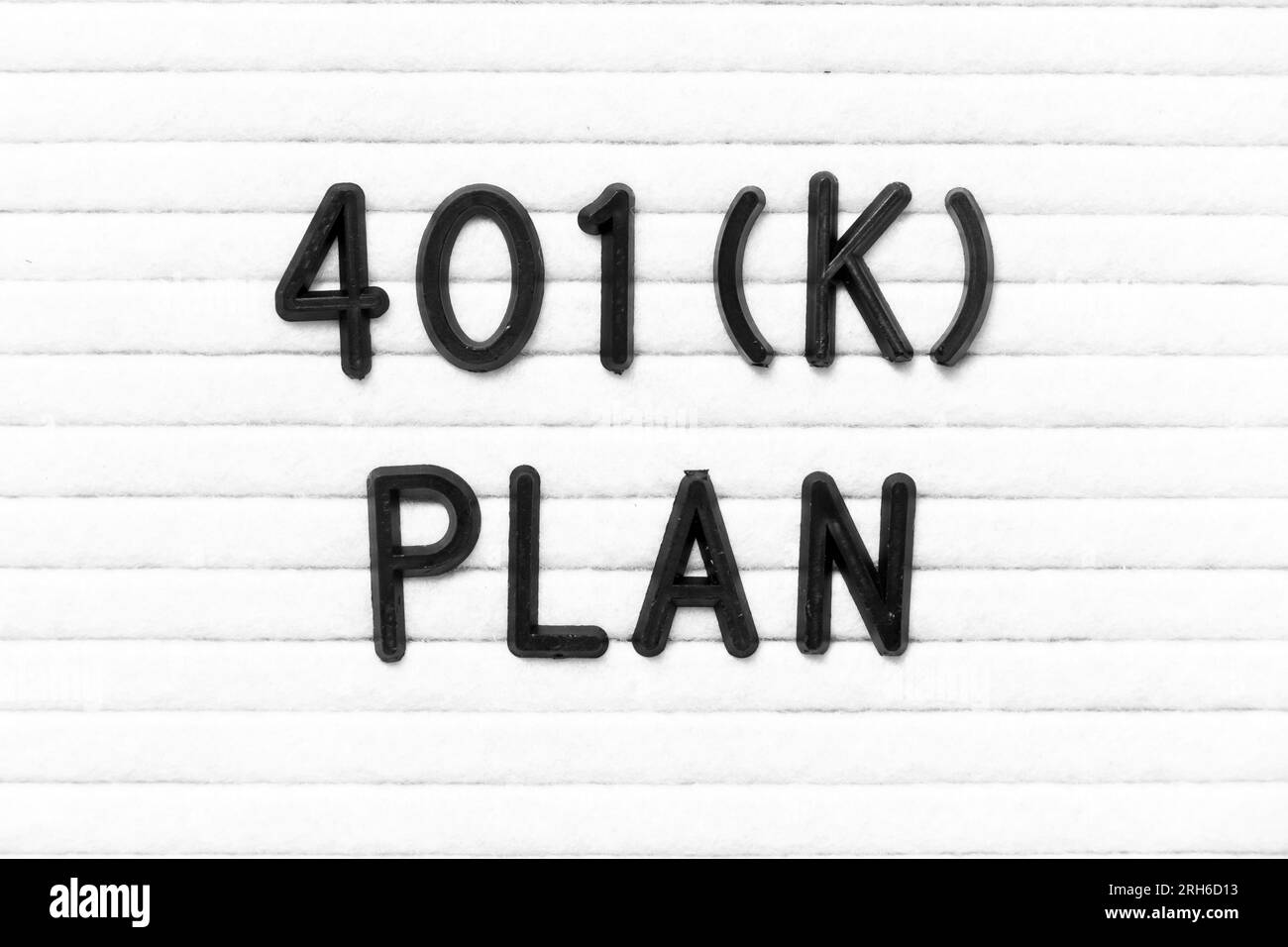 Black color letter in word 401(K) plan on white felt board background ...