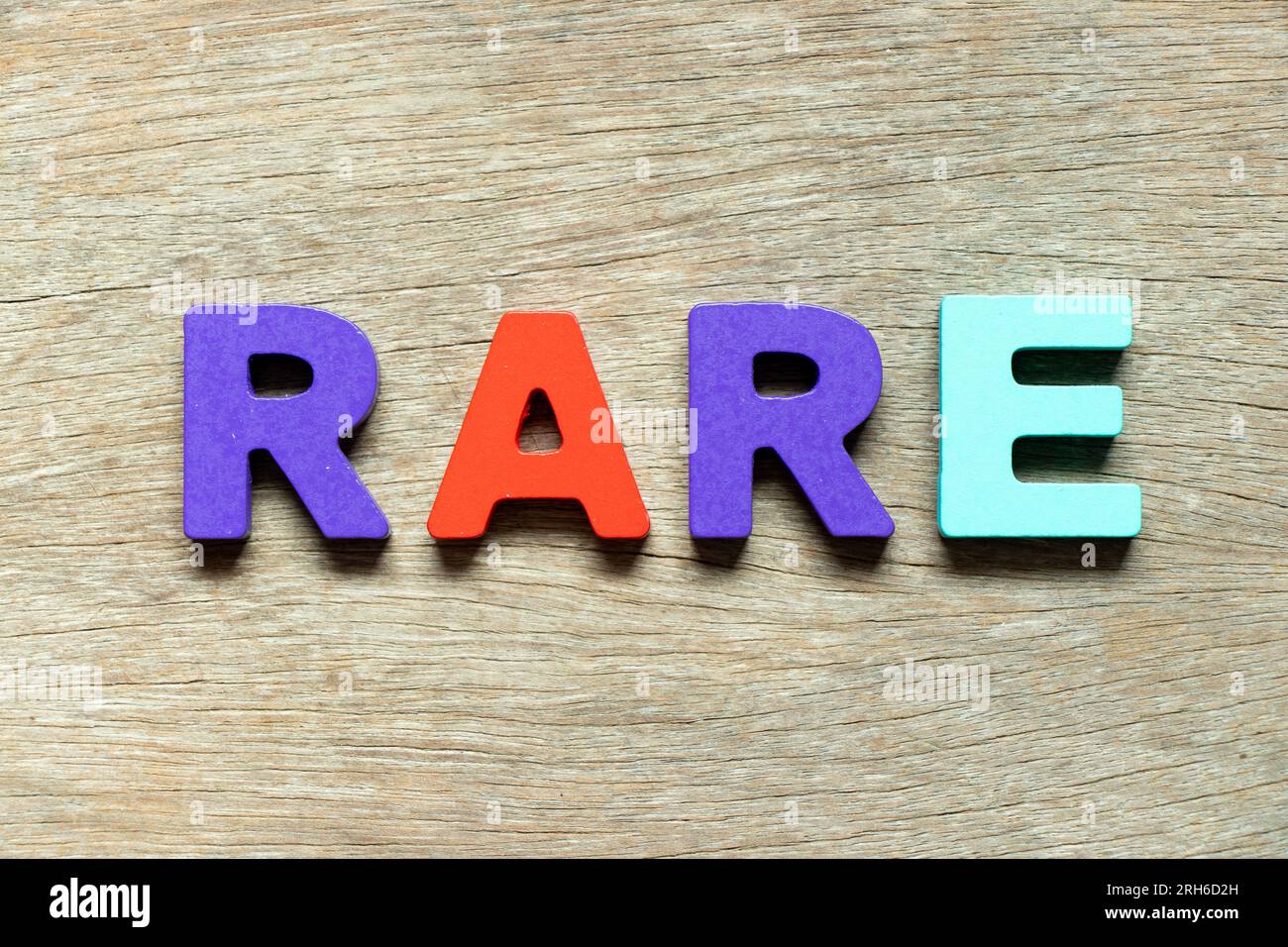 Color alphabet letter in word rare on wood background Stock Photo - Alamy