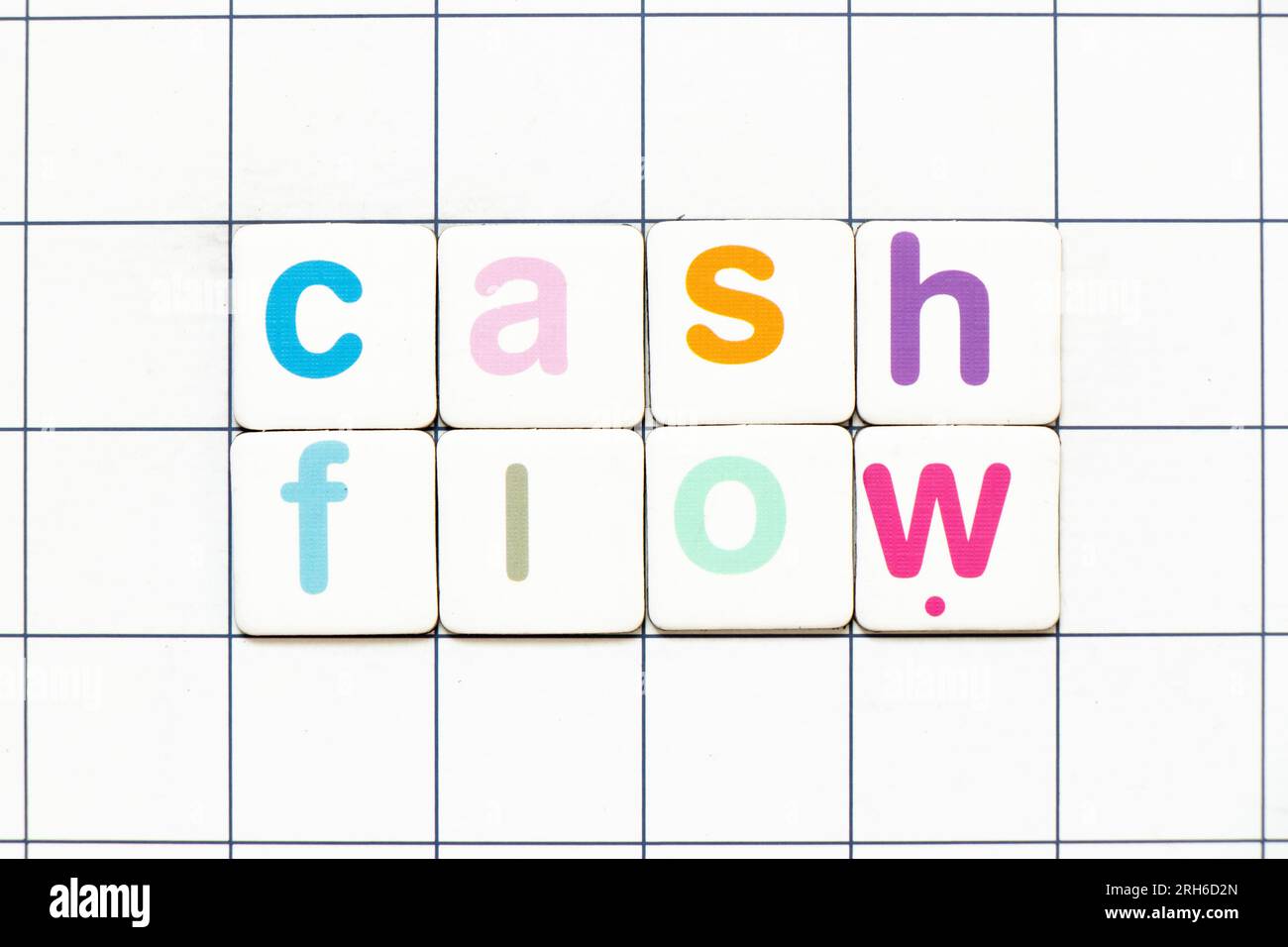 Colorful tile letter in word cash flow on white grid background Stock ...