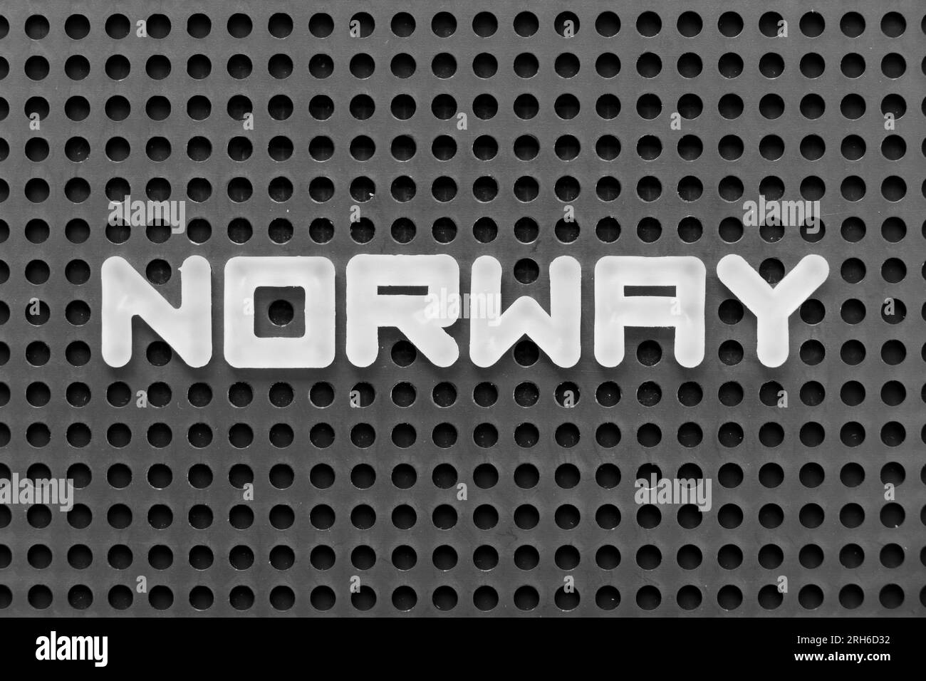 White alphabet letter in word norway on black pegboard background Stock ...