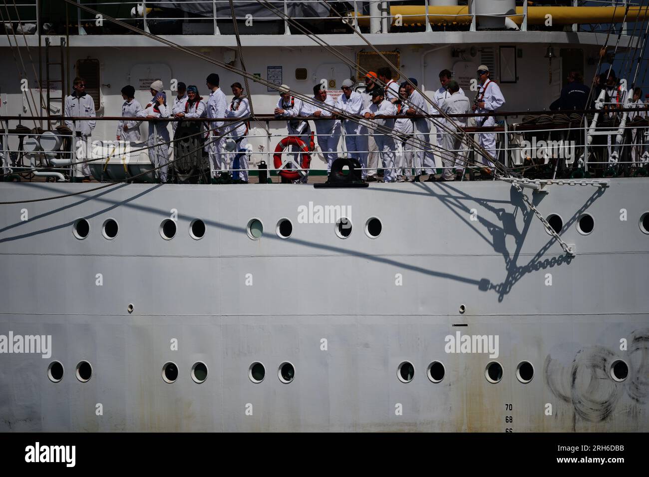 The crew aboard the class-A tall ship Dar Mlodziezy, from Poland, on deck as they arrive into ...