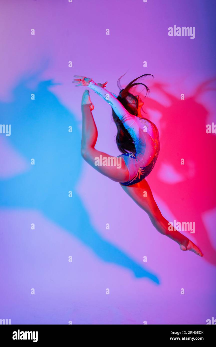 High jump, flight. Little flexible girl, rhythmic gymnastics artist ...