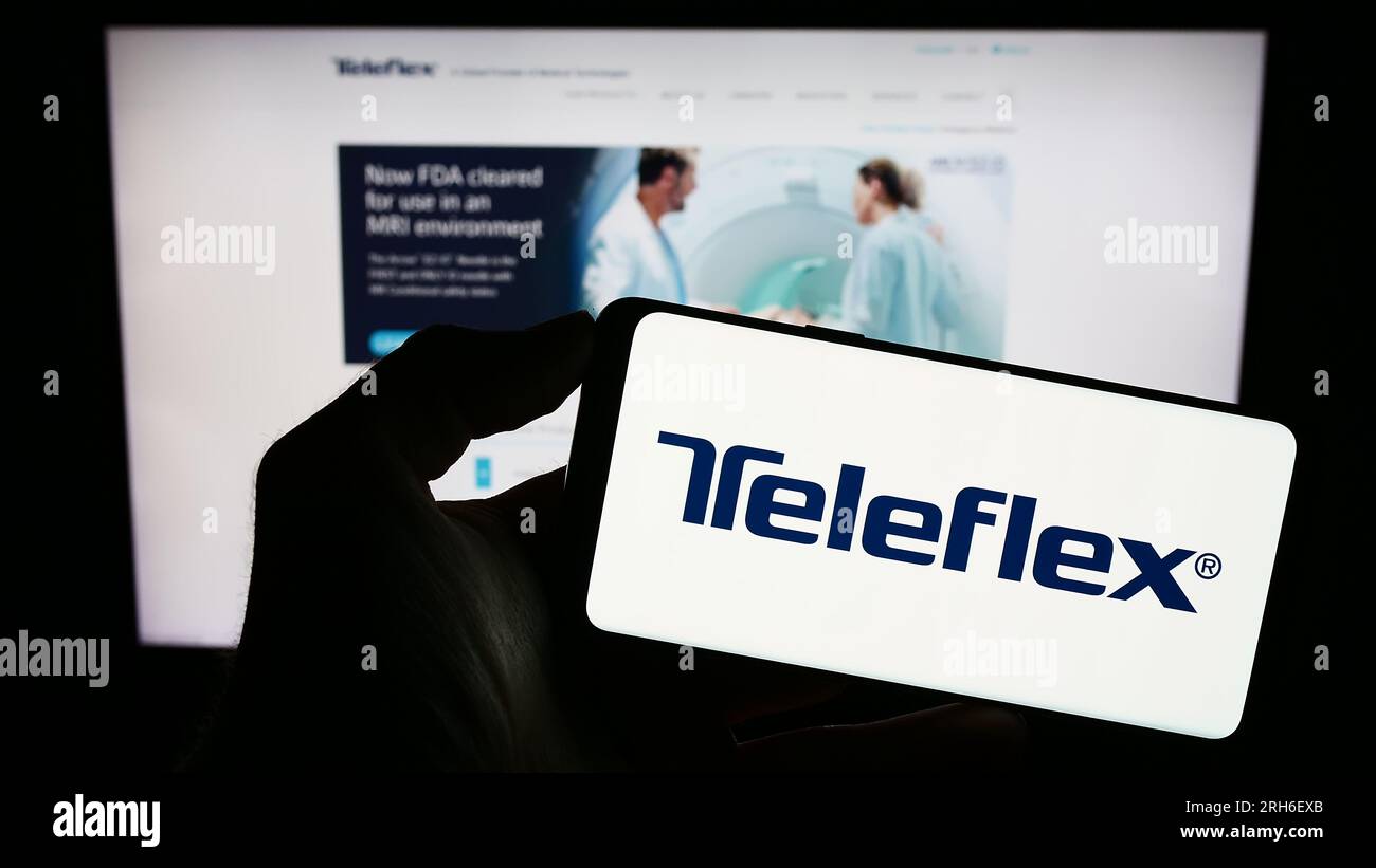 Person holding cellphone with logo of US medical devices company Teleflex Incorporated on screen ...