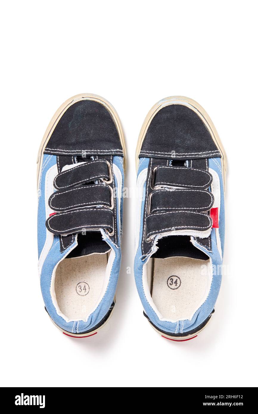 Used blue pair of baby sneakers isolated on white background with ...