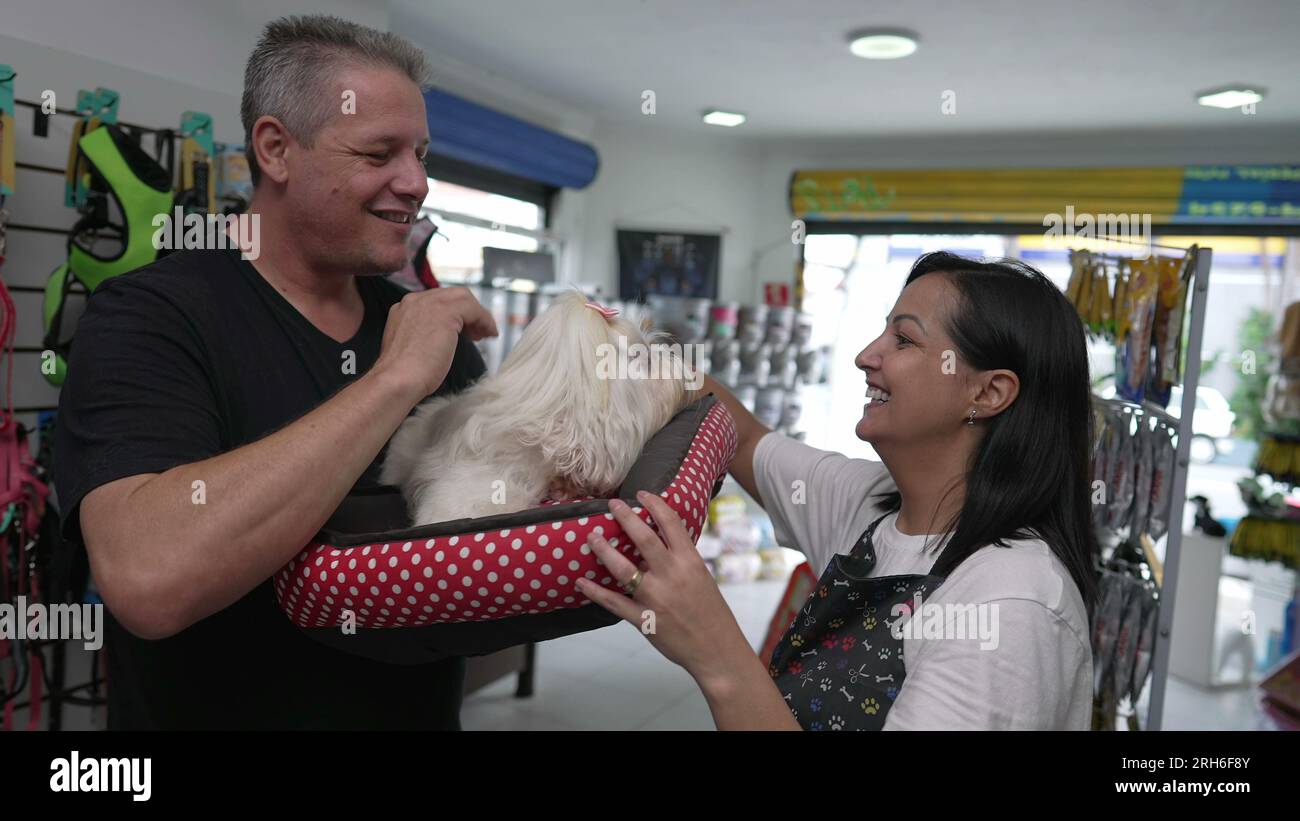 Happy Pet client holding his Small Dog after bath. Female business ...