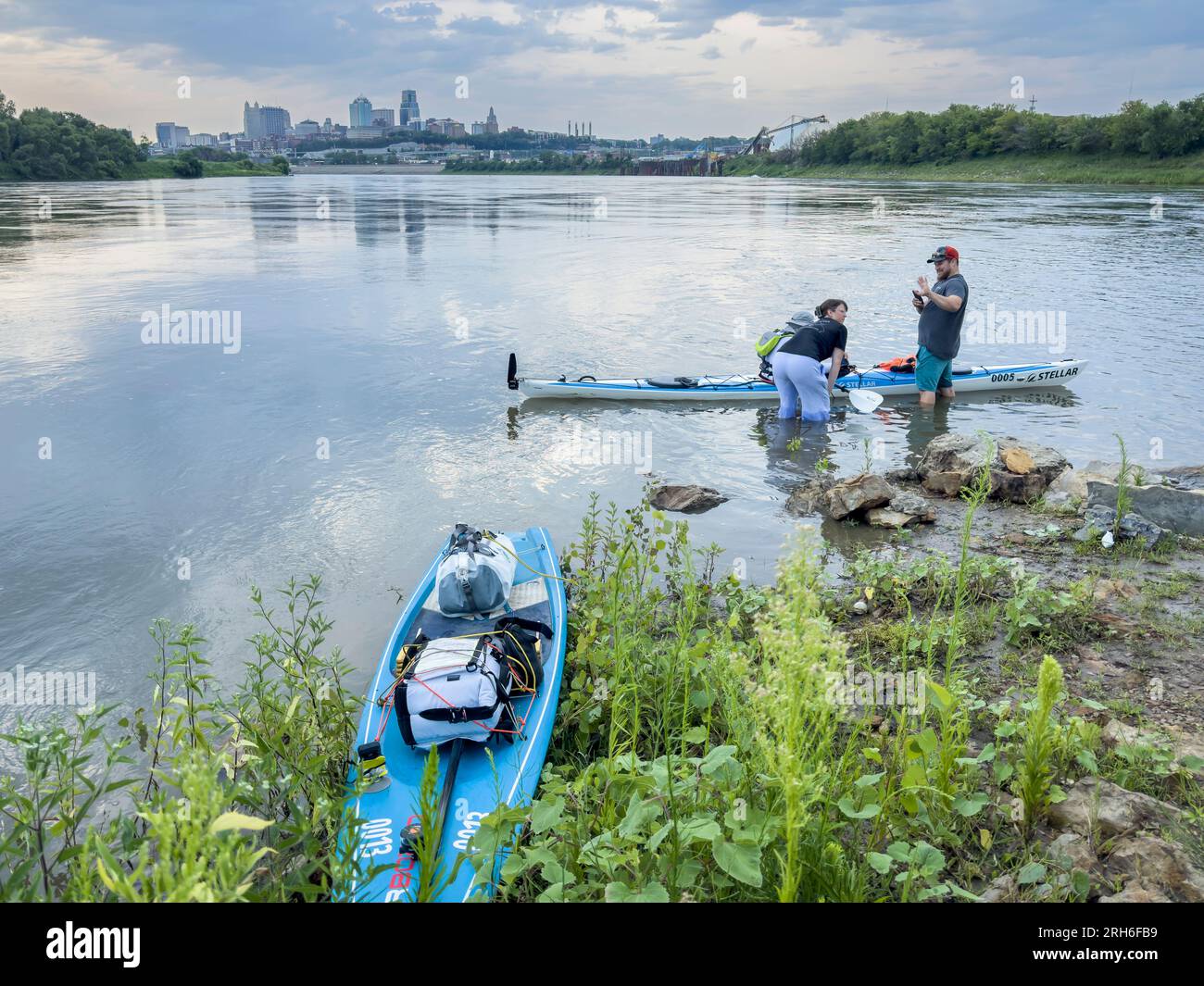 Kansas City, KS, USA - August 1, 2023: Paddlers launching kayak and ...