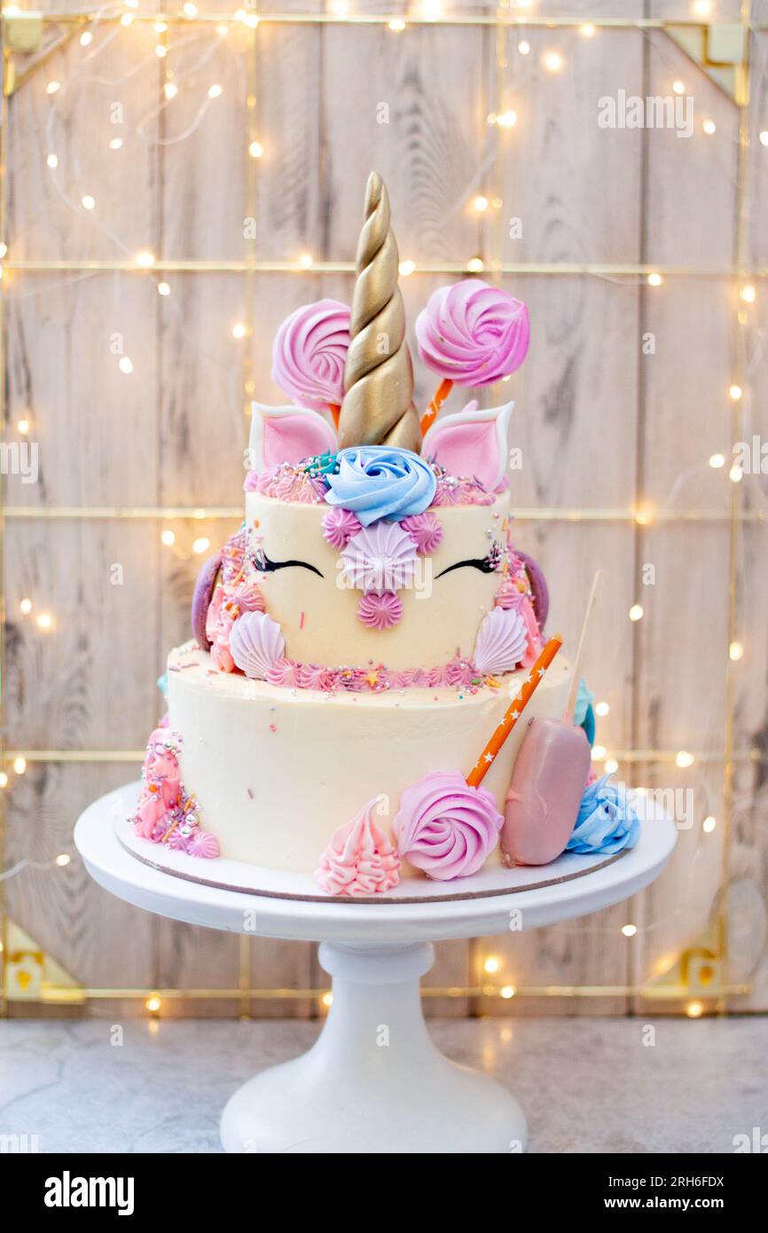 Two layered birthday unicorn cake with golden fondant horn, eyelashes ...
