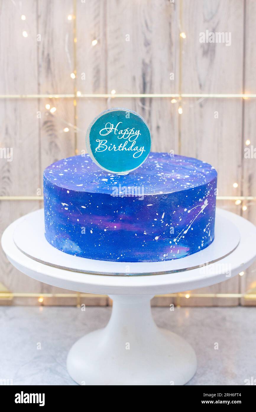 Birthday blue cosmic cake on festive background with text Happy ...