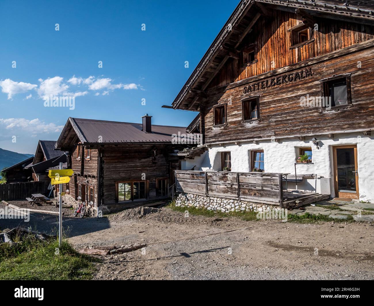 The image is of the Sattelberg Alm mountain refuge located in the ...