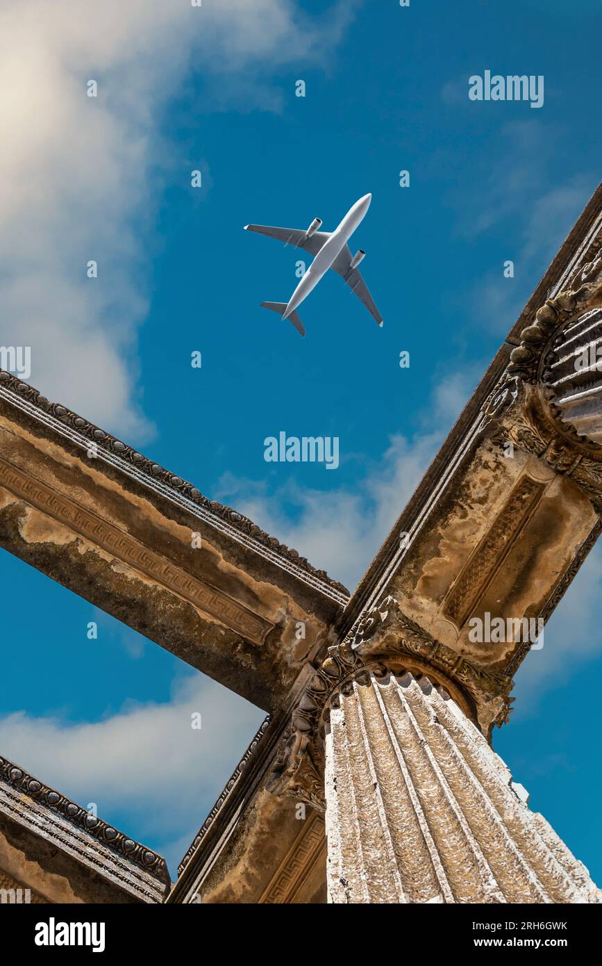 Airplane seen from bottom to top between the columns of the temple of ...