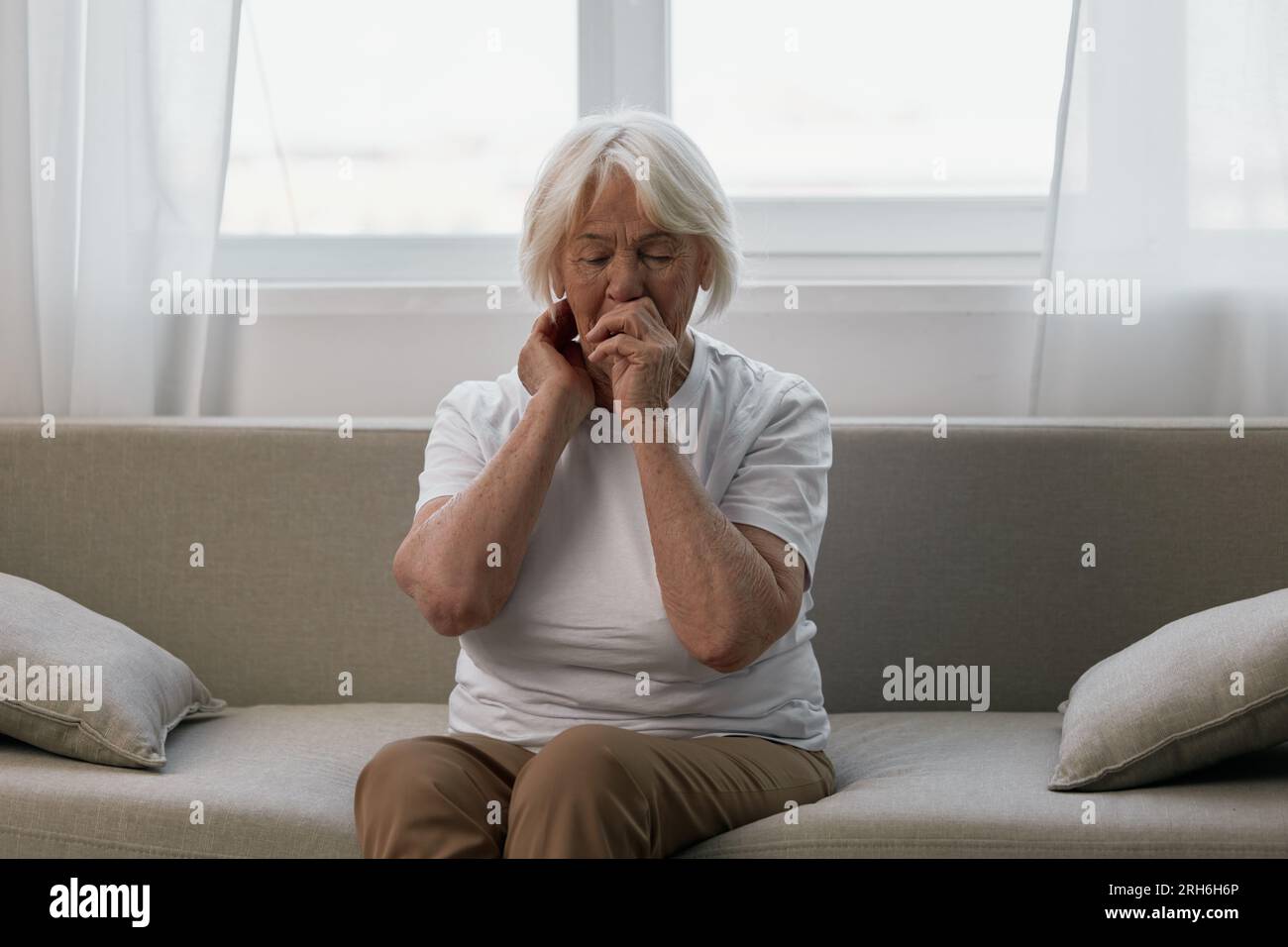 Elderly woman severe tooth pain sitting on the couch, health problems ...