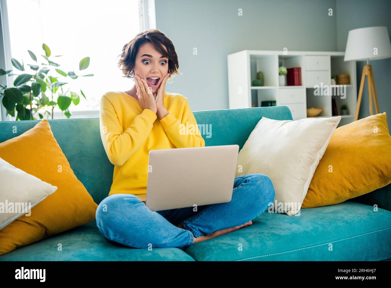 Photo of funny shocked lady browsing netbook impressed incredible ...