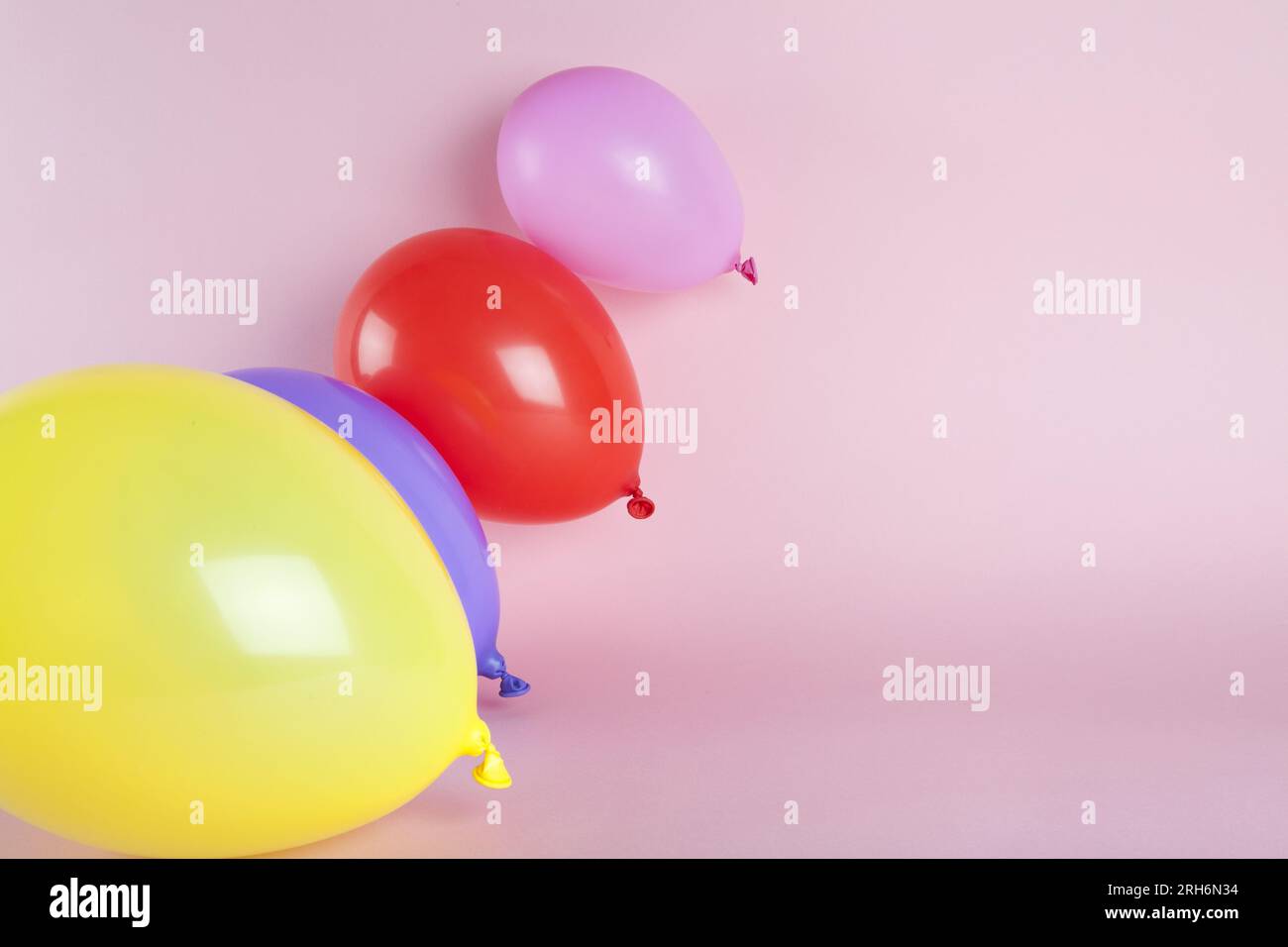 balloons in harmonious colors on a pink background. Minimal color still ...