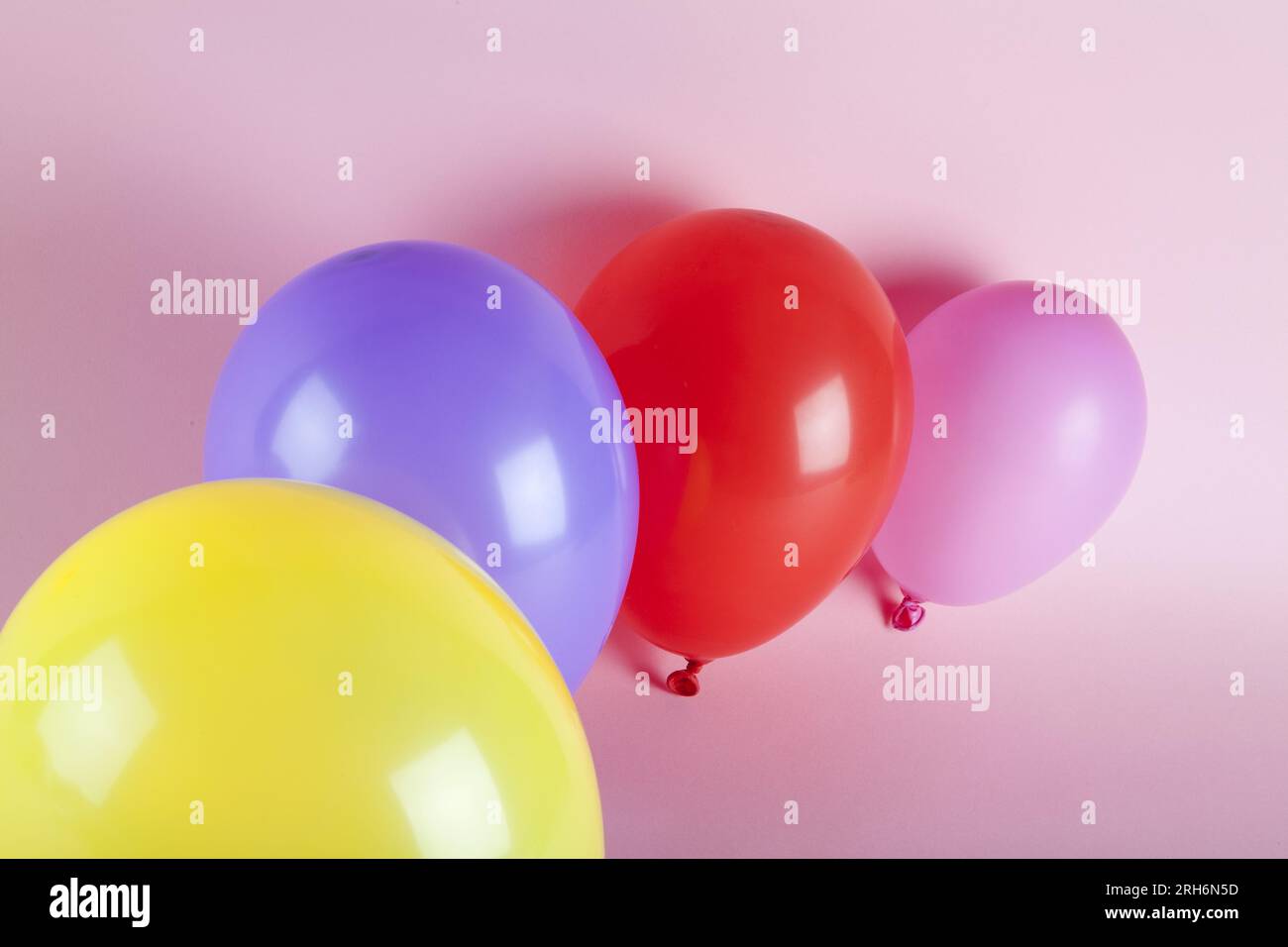 balloons in harmonious colors on a pink background. Minimal color still ...