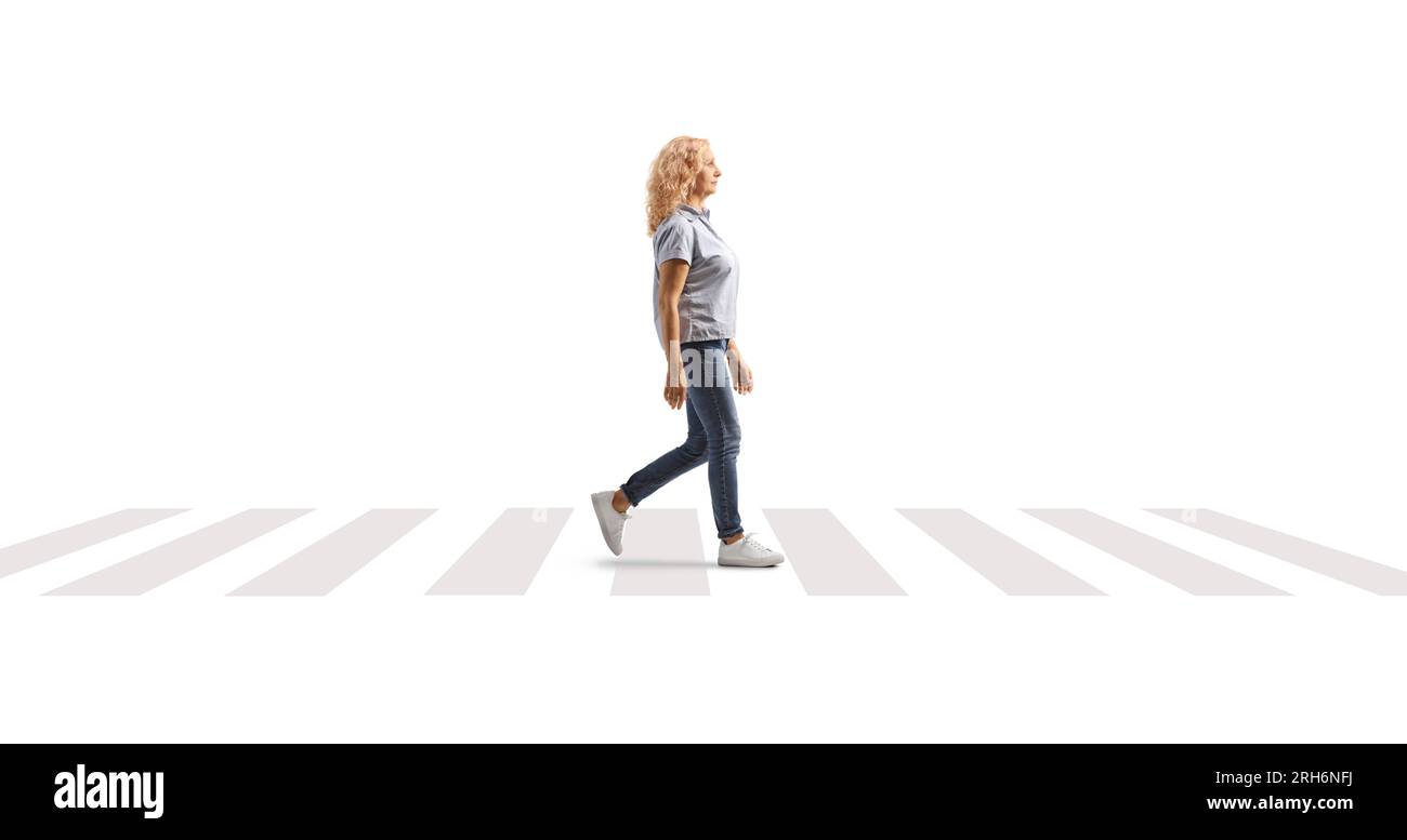 Woman walking on a street at a pedestrian crosswalk isolated on white ...