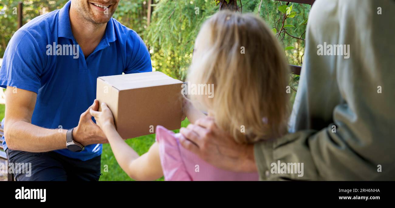 courier service. mother with child accepting home delivery package from ...
