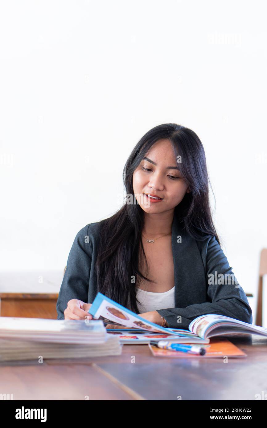 Young female student study in the school library. white background ...