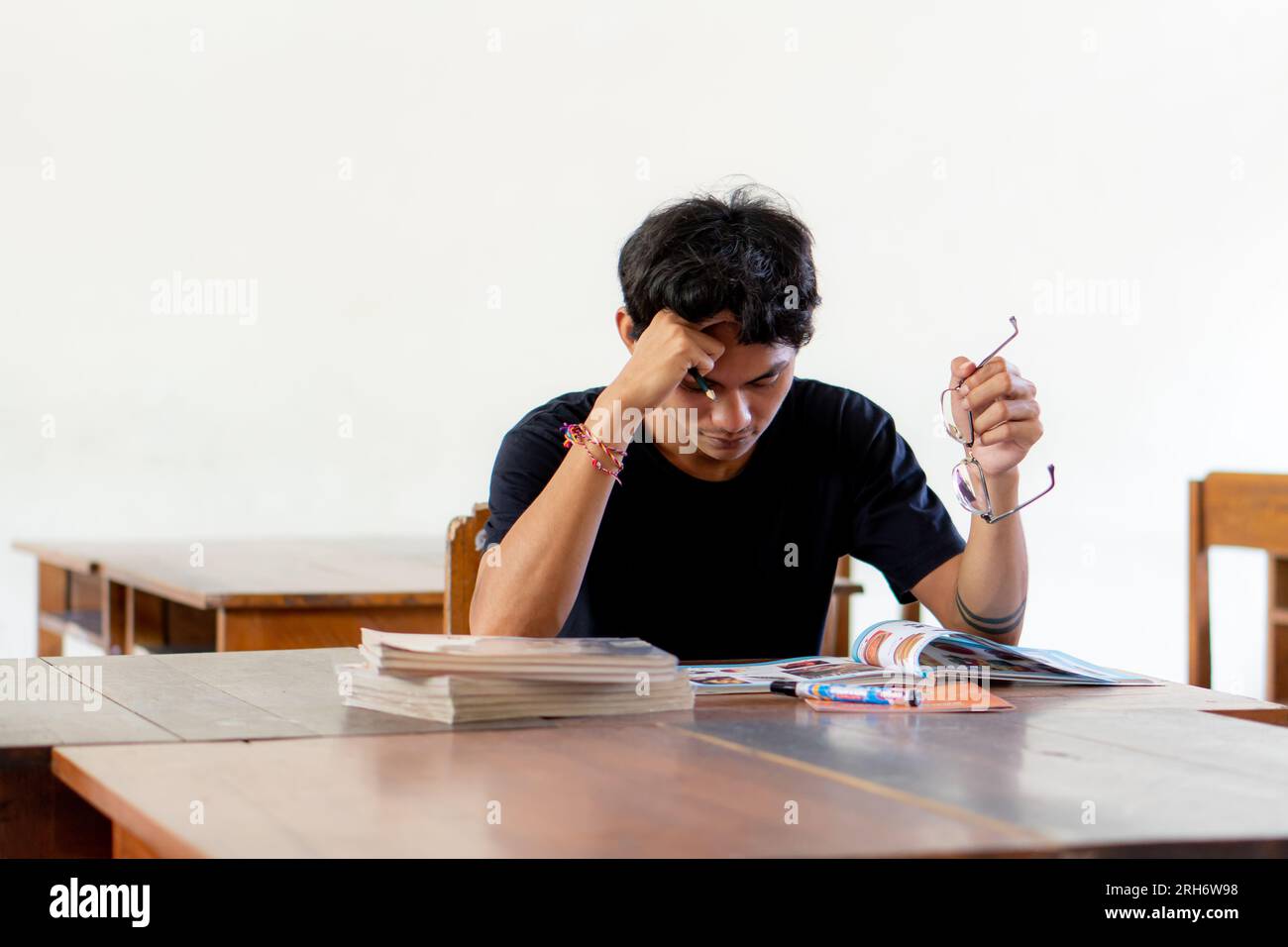 Overworked and tired high school student man studying feeling depressed ...