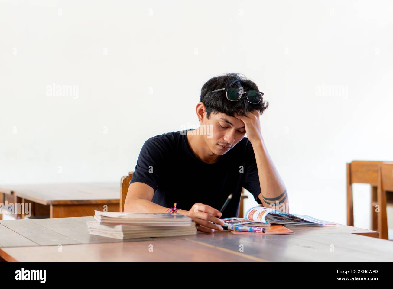 Overworked and tired high school student man studying feeling depressed ...