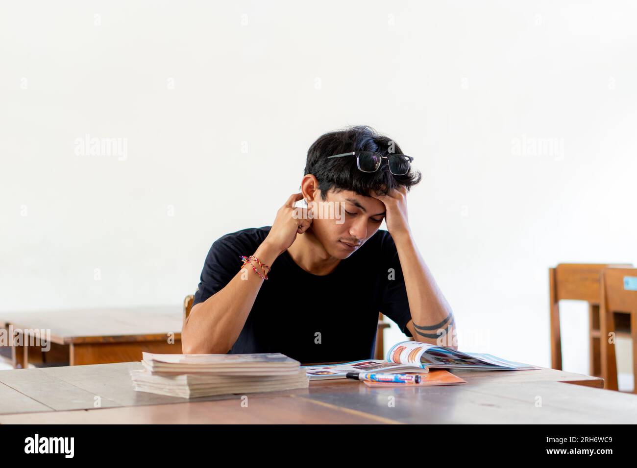 Overworked and tired high school student man studying feeling depressed ...