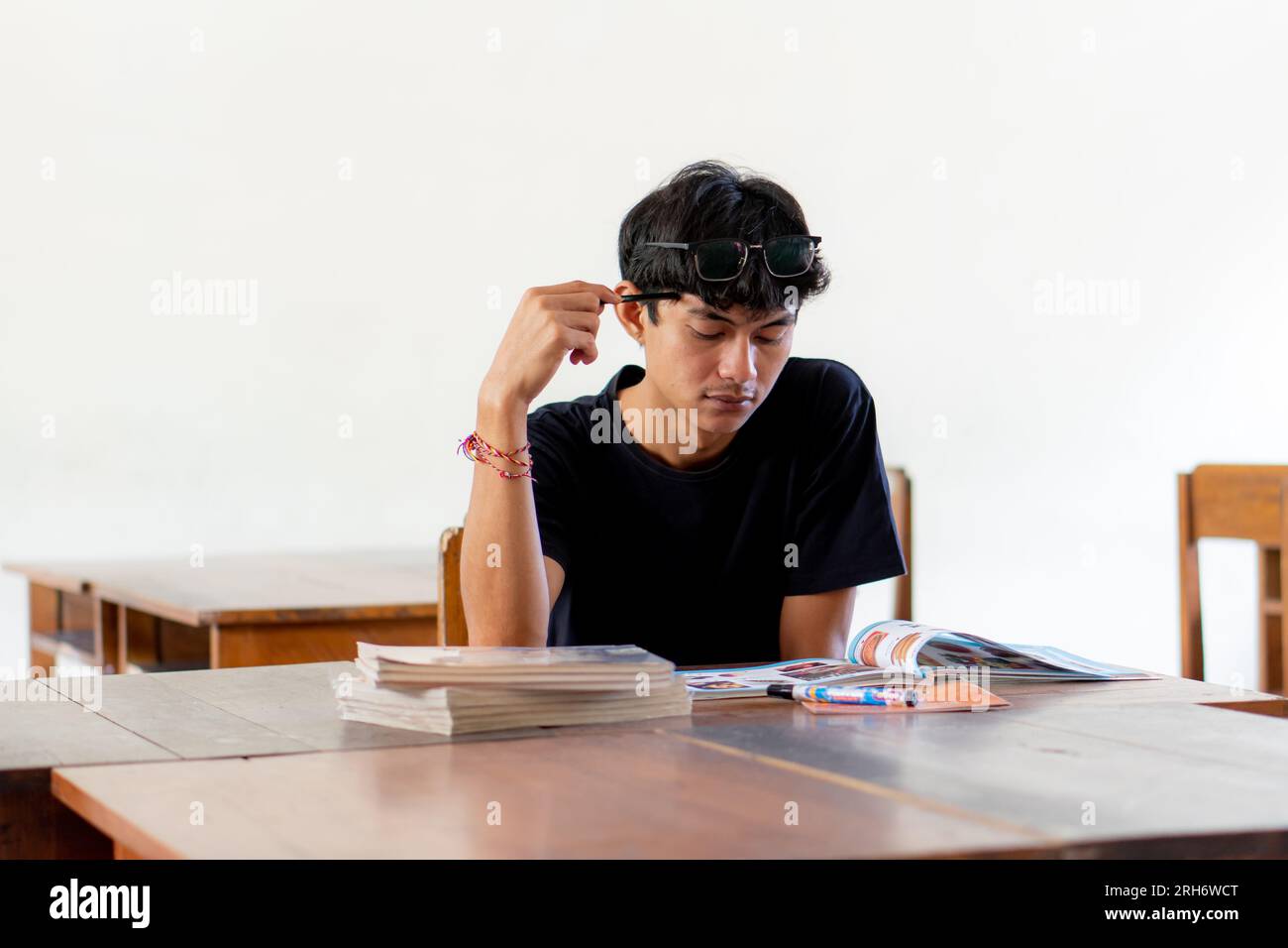 Overworked and tired high school student man studying feeling depressed ...